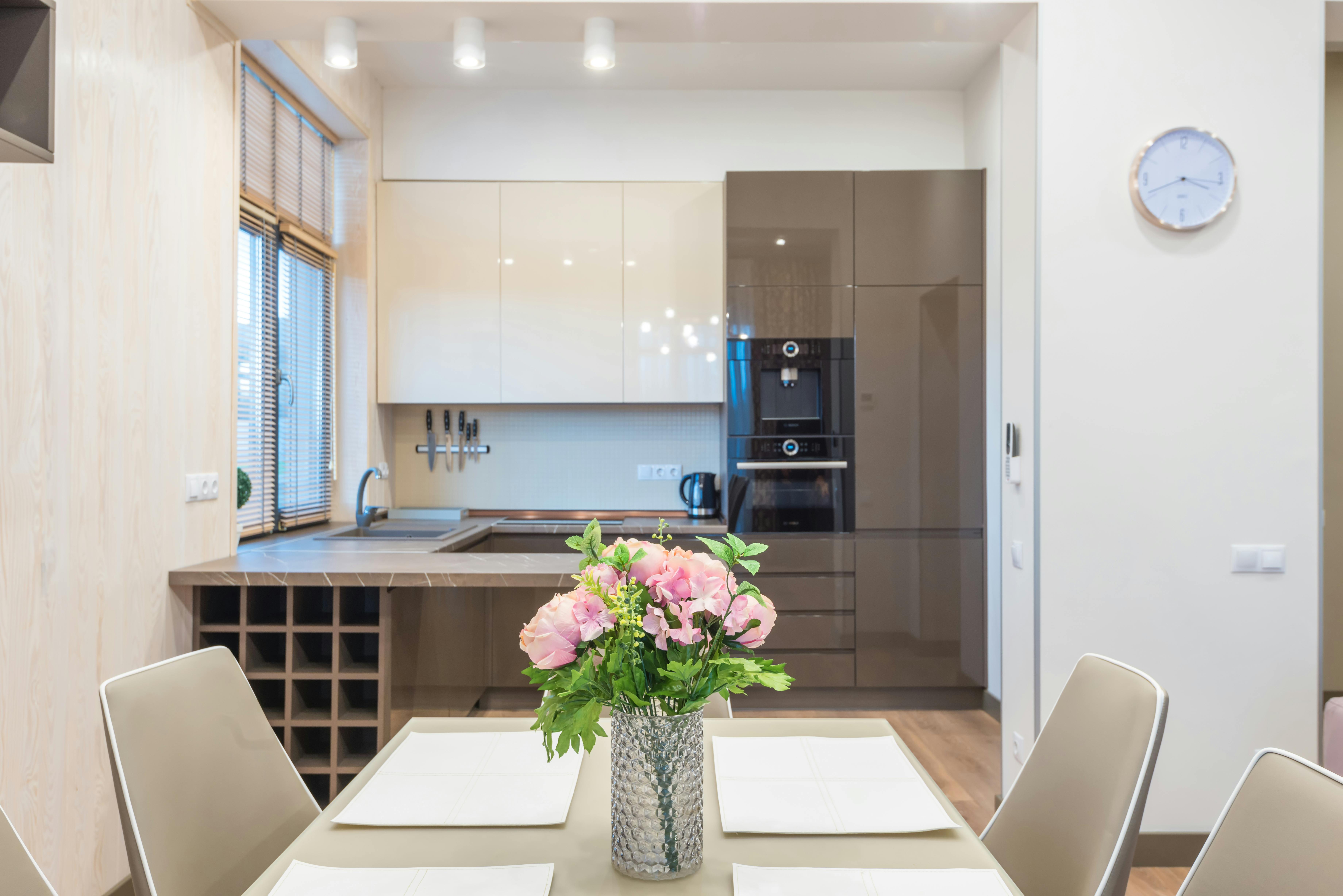 Kitchen with modern furniture and dining table decorated with bunch of ...