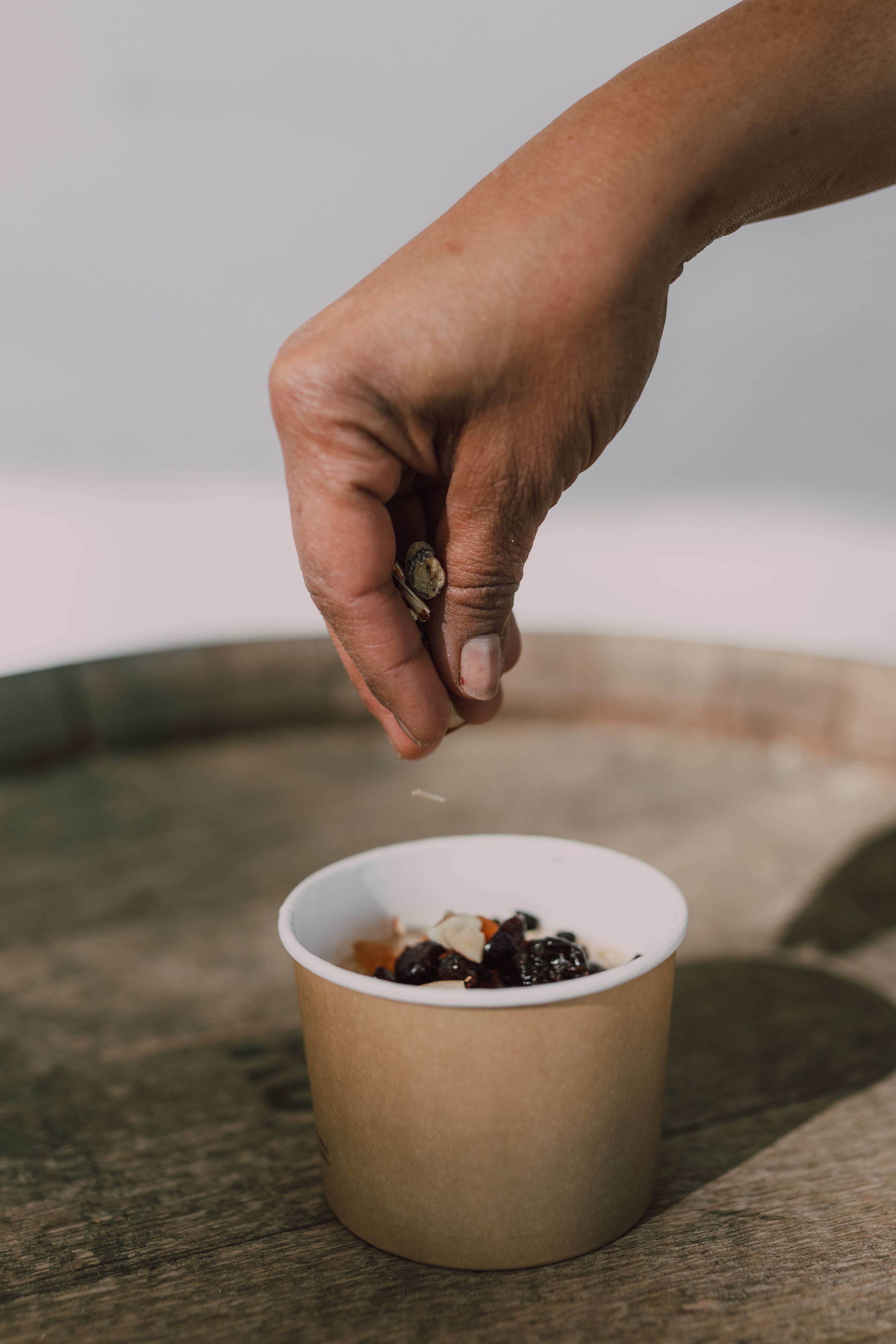 Selective Focus Photography of Person Holding Vacenza Labeled Cup ...