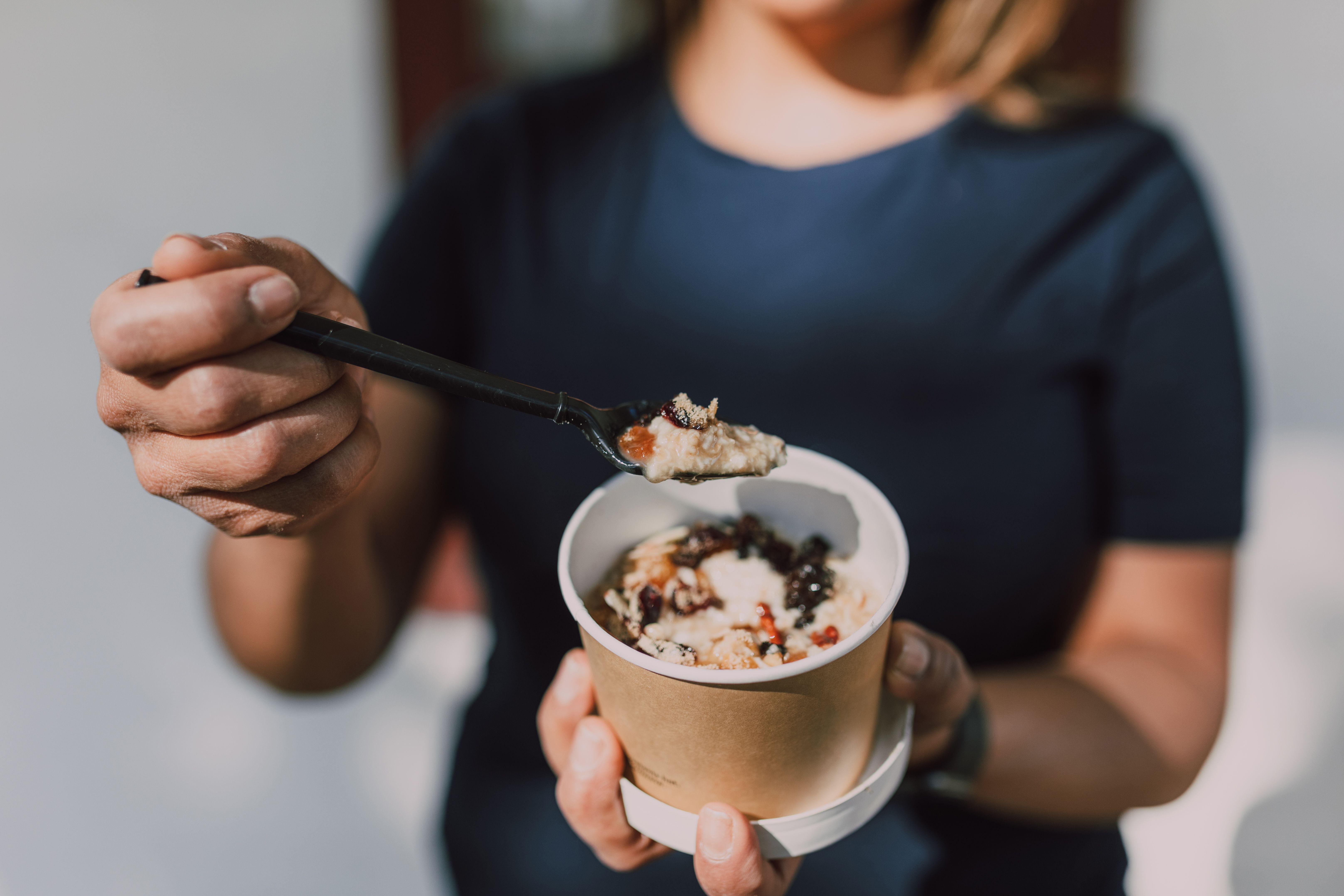 Selective Focus Photography of Person Holding Vacenza Labeled Cup ...