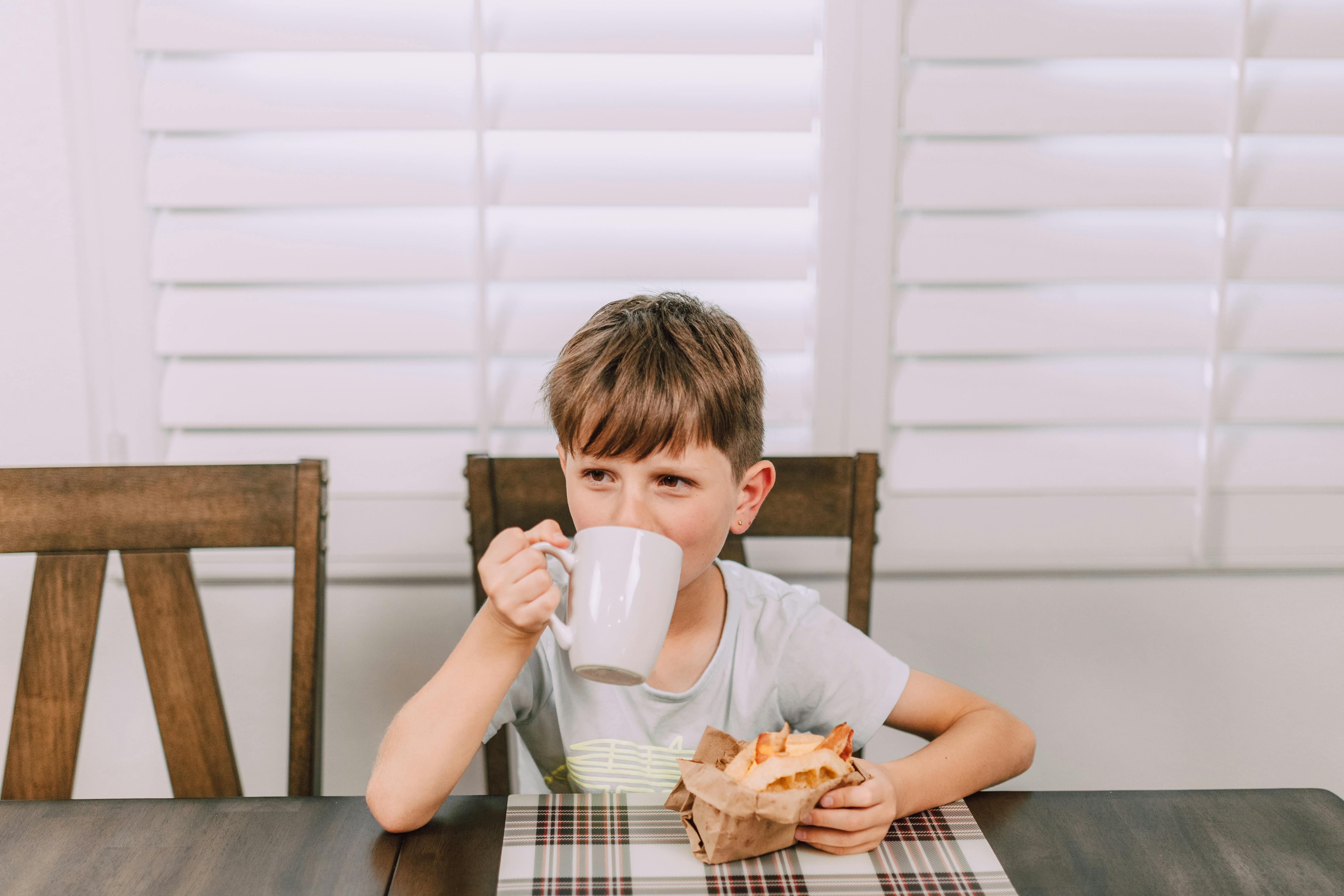 Kid drinking from a Coffee Mug · Free Stock Photo