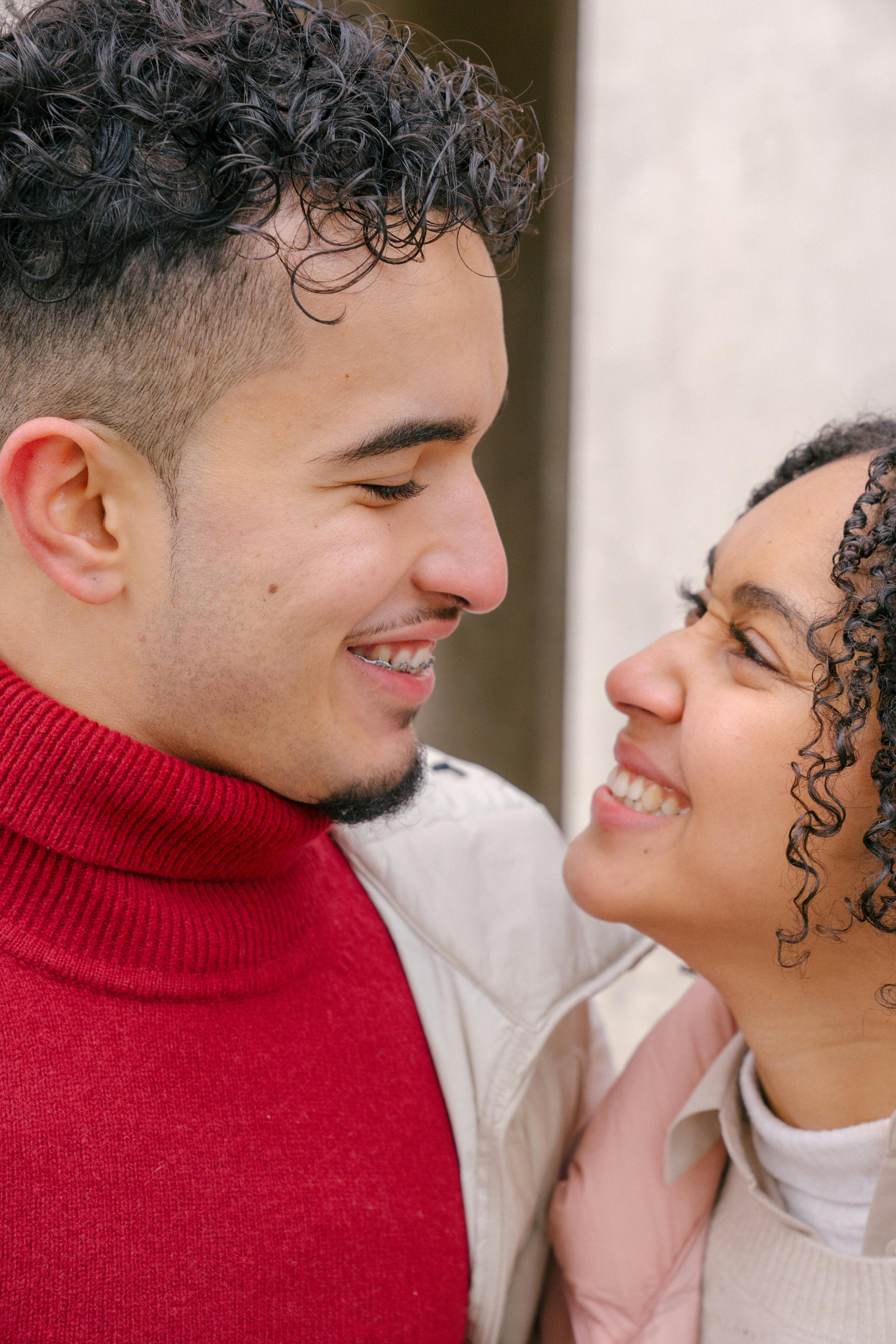 Cheerful young Hispanic couple cuddling and smiling on street · Free ...