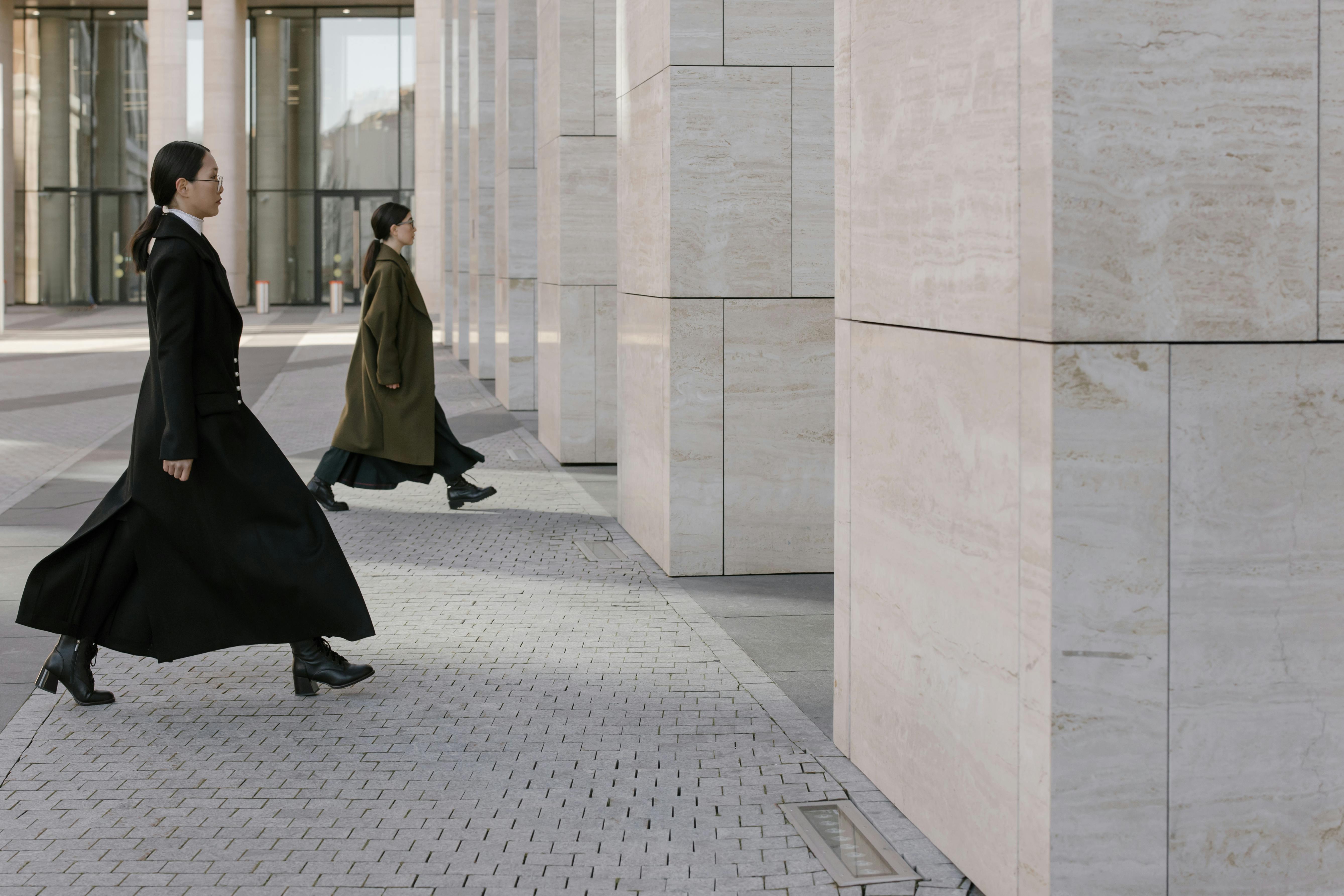 Women Wearing Coats Walking Near Building · Free Stock Photo