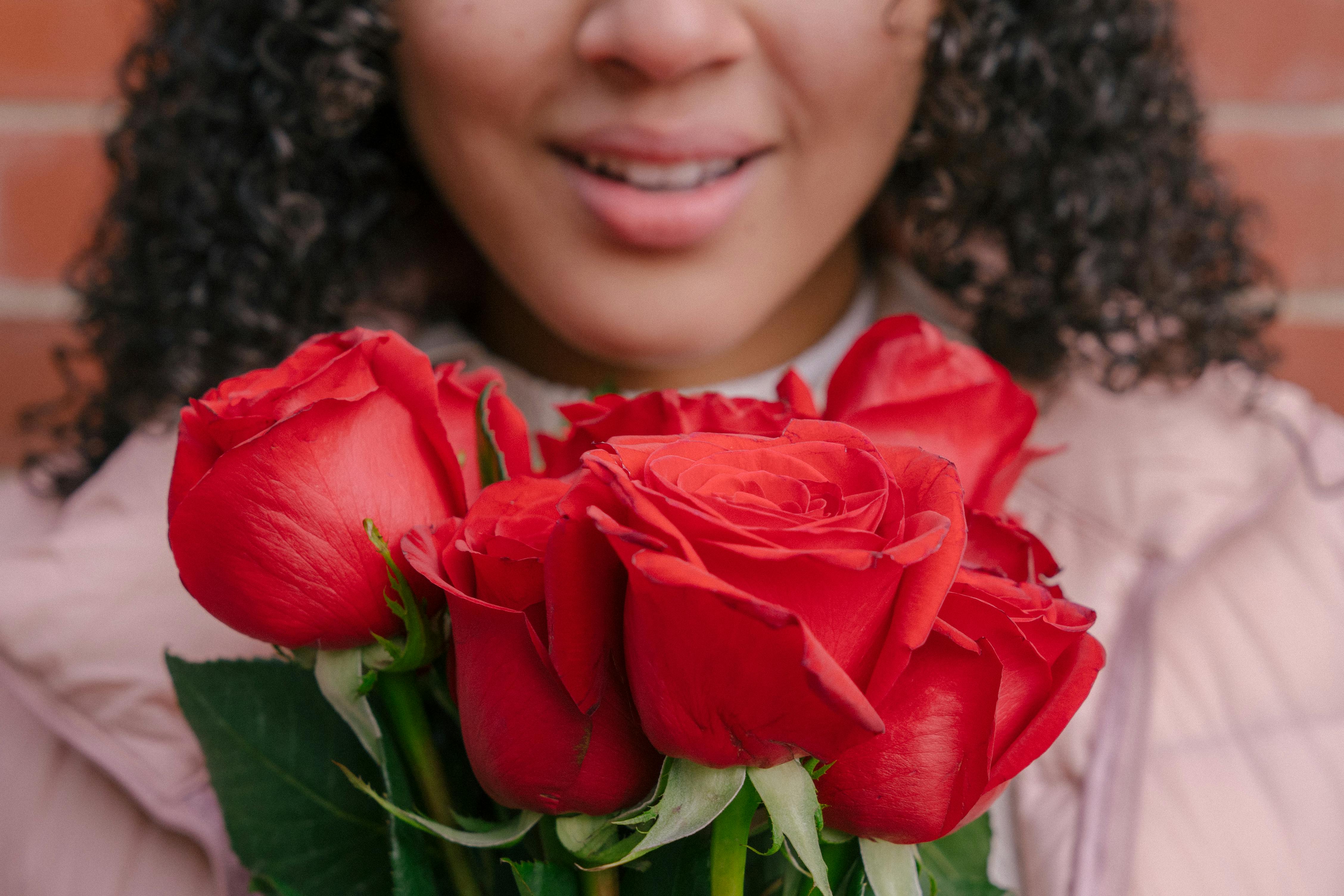 Person Holding Red Rose Selective Focal Photo · Free Stock Photo