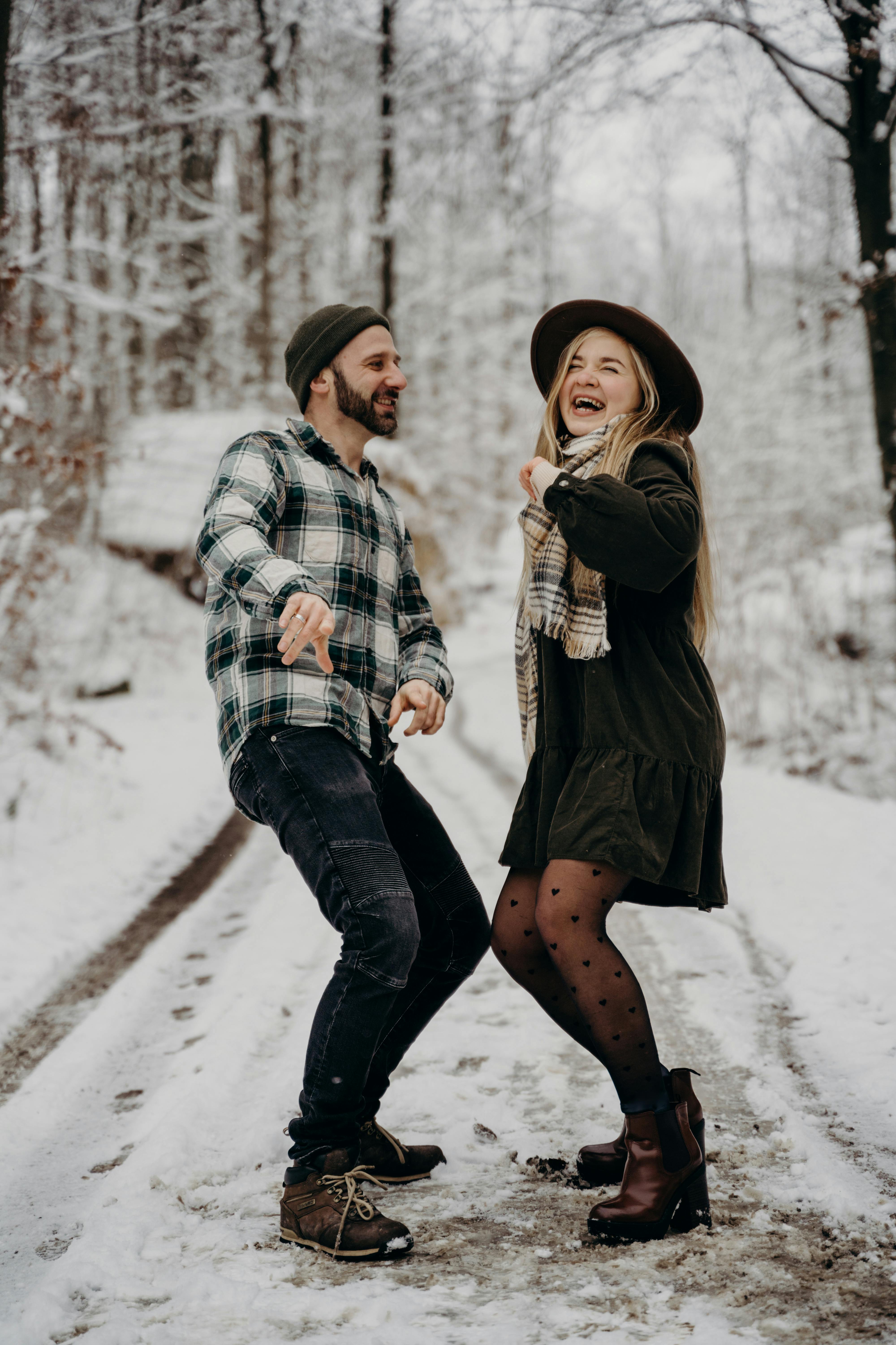 A Couple Dancing in the Middle of a Snow Covered Road · Free Stock Photo