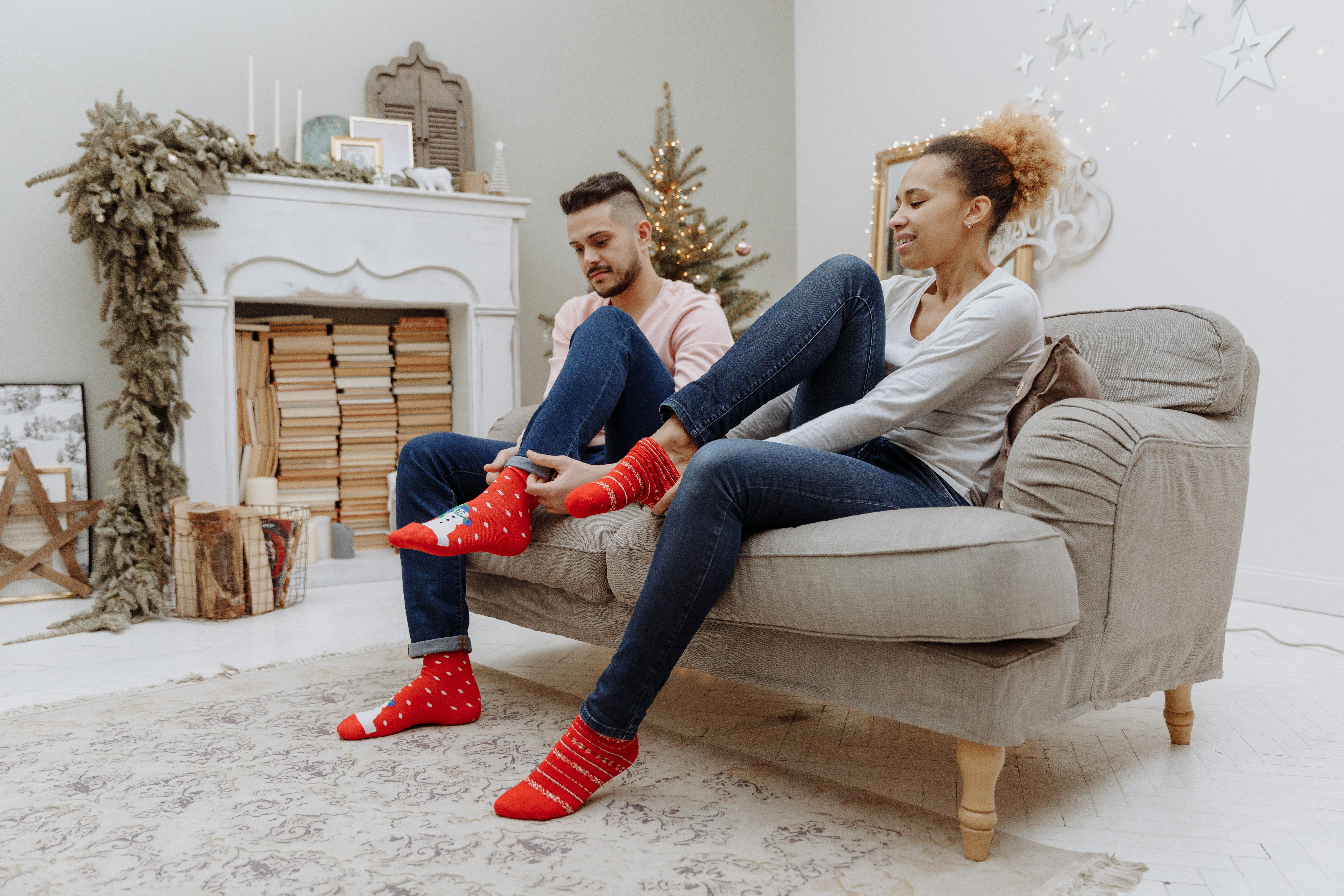 Man and Woman Sitting on Brown Couch Wearing Red and White Socks · Free ...