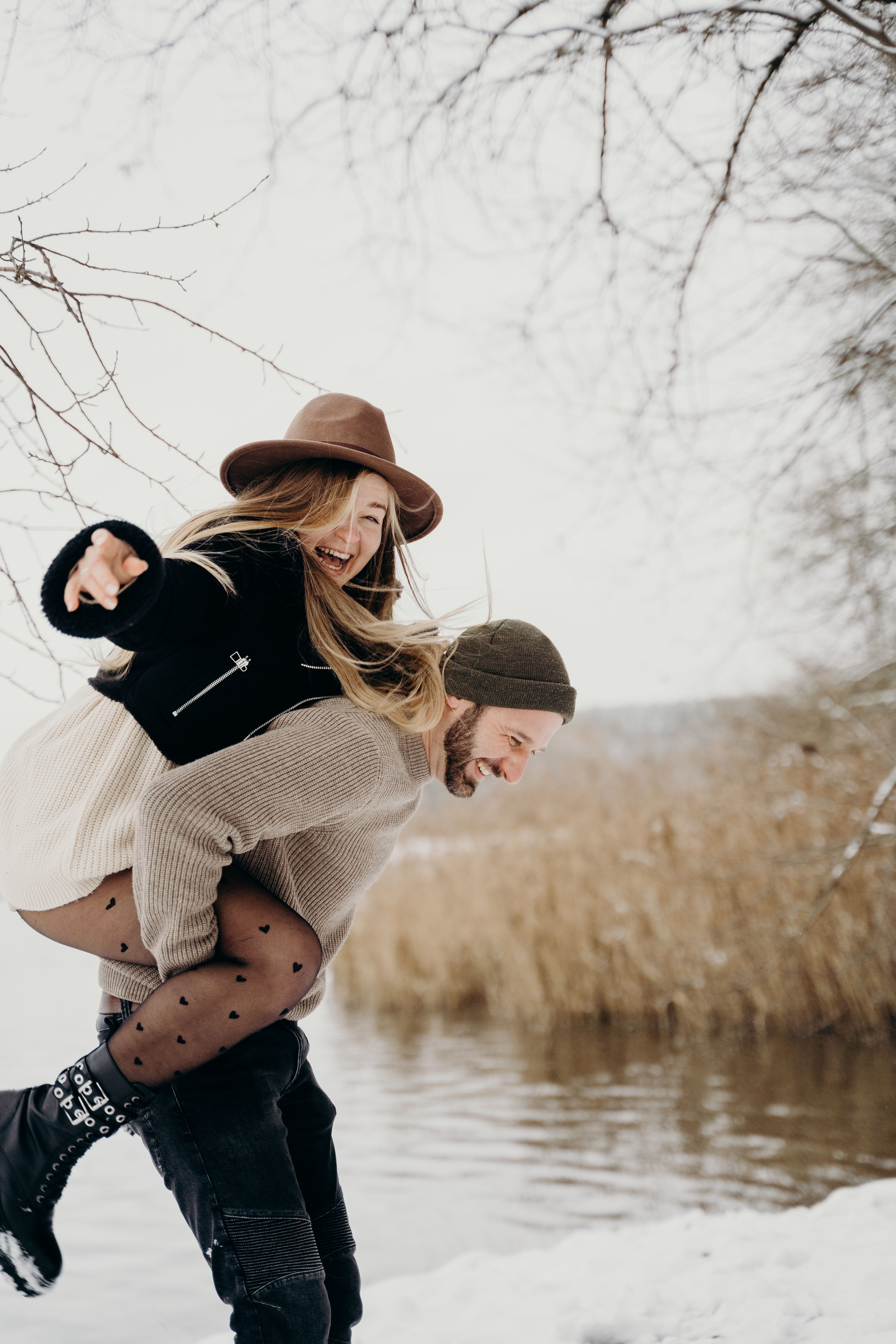 A Man Lifting a Woman over His Shoulder · Free Stock Photo