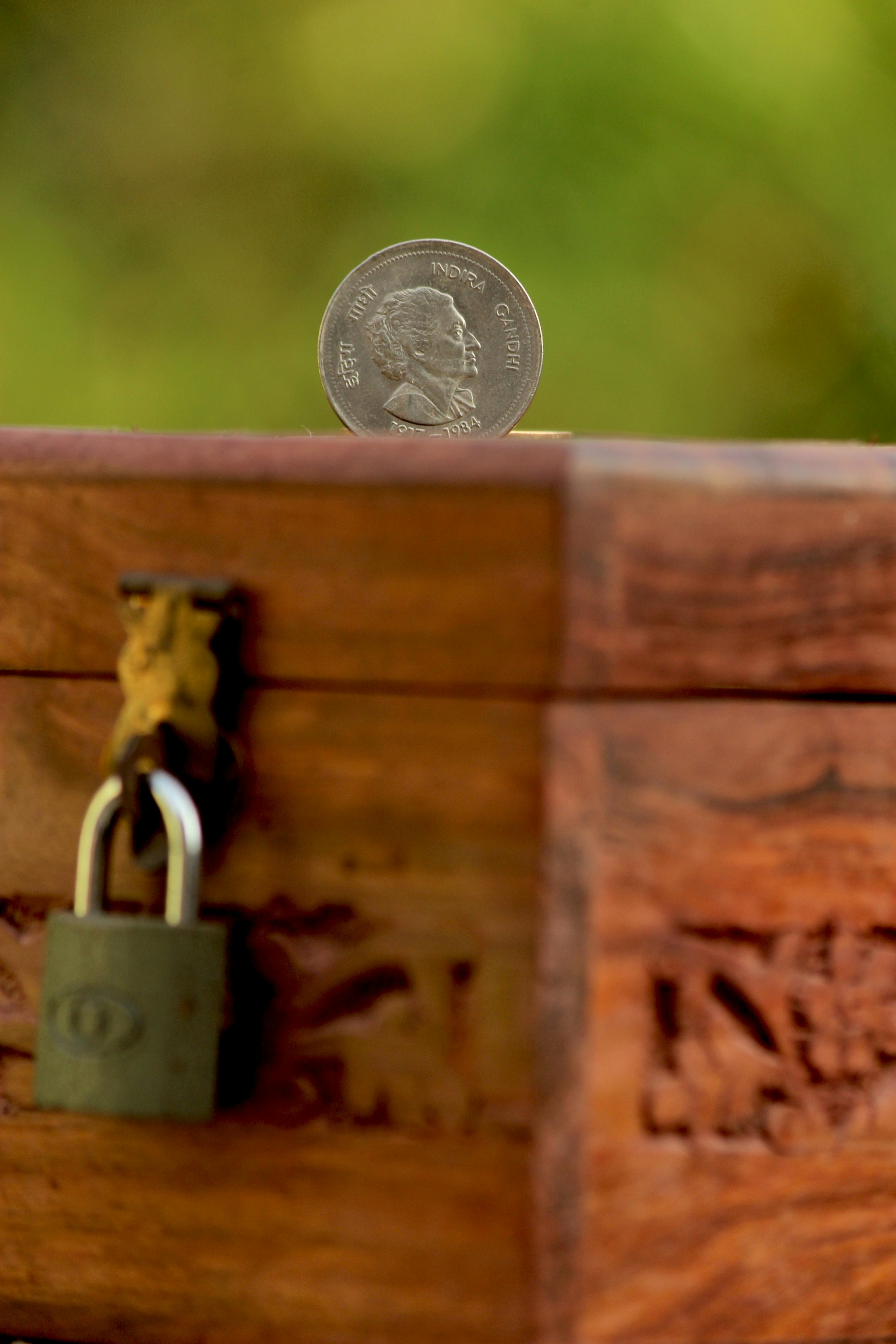 An Indira Gandhi Indian Rupee on a Wooden Box with Padlock · Free Stock ...