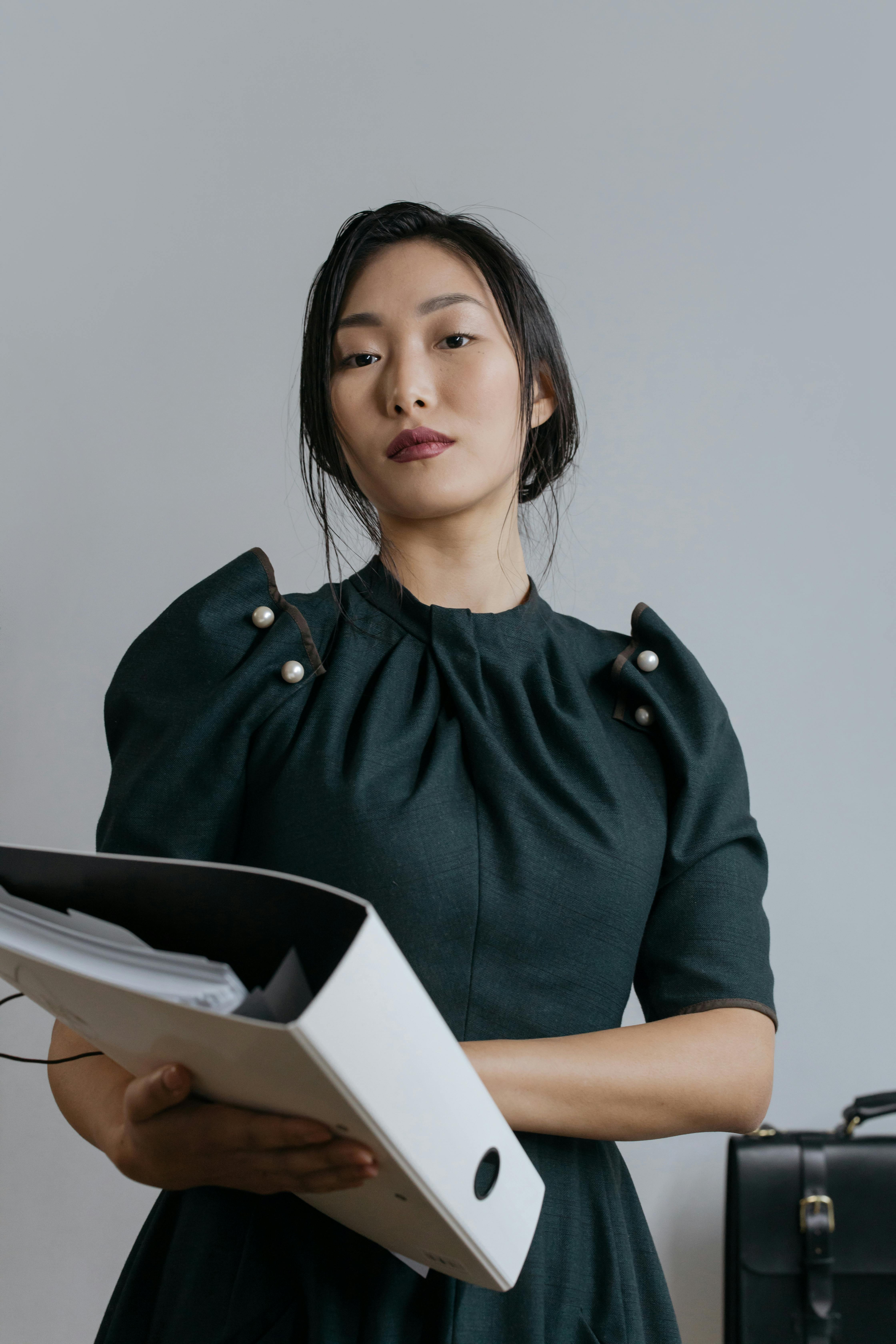 A Woman Holding Organizers · Free Stock Photo