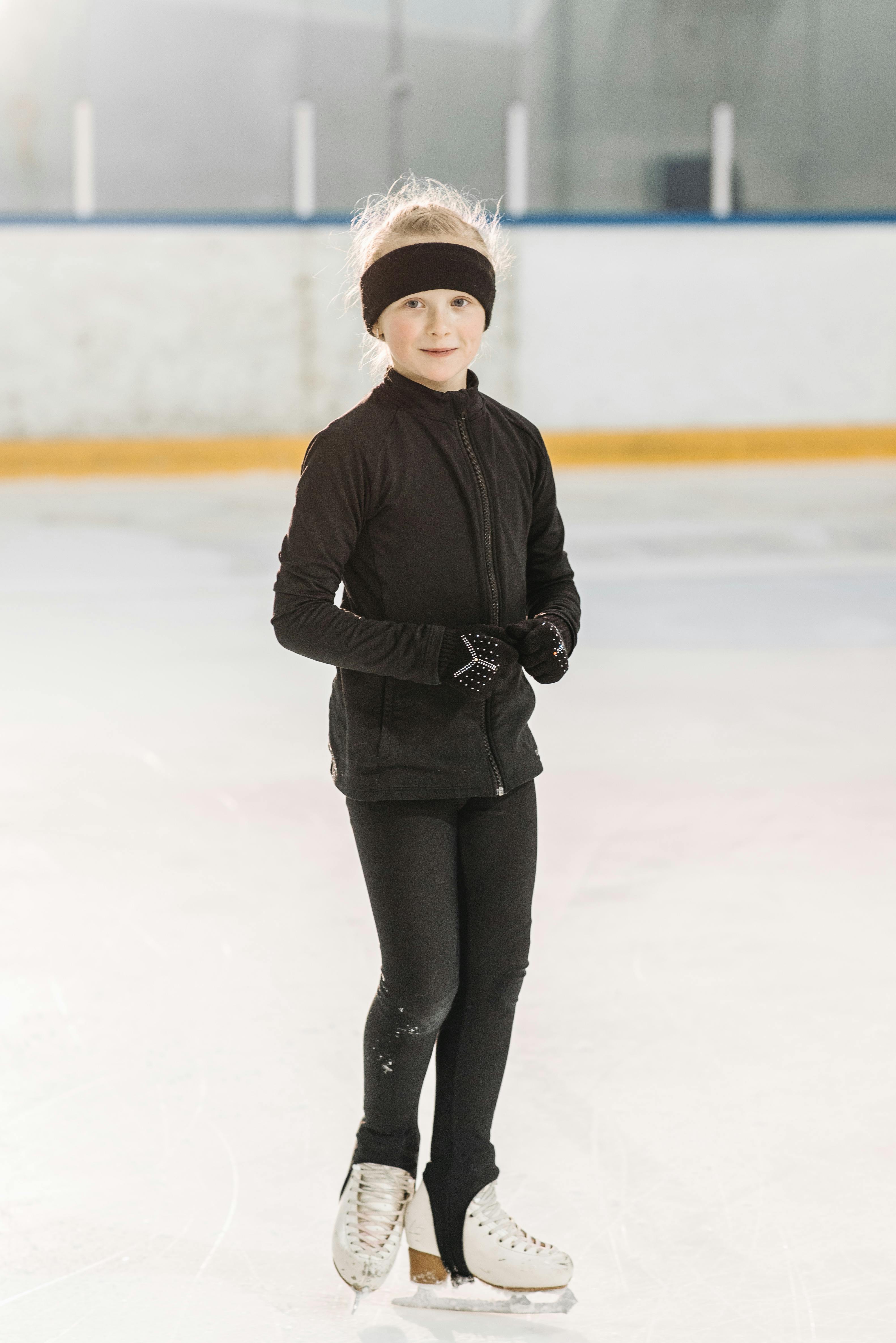 Young Girl Wearing Ice Skates Standing on Ice · Free Stock Photo