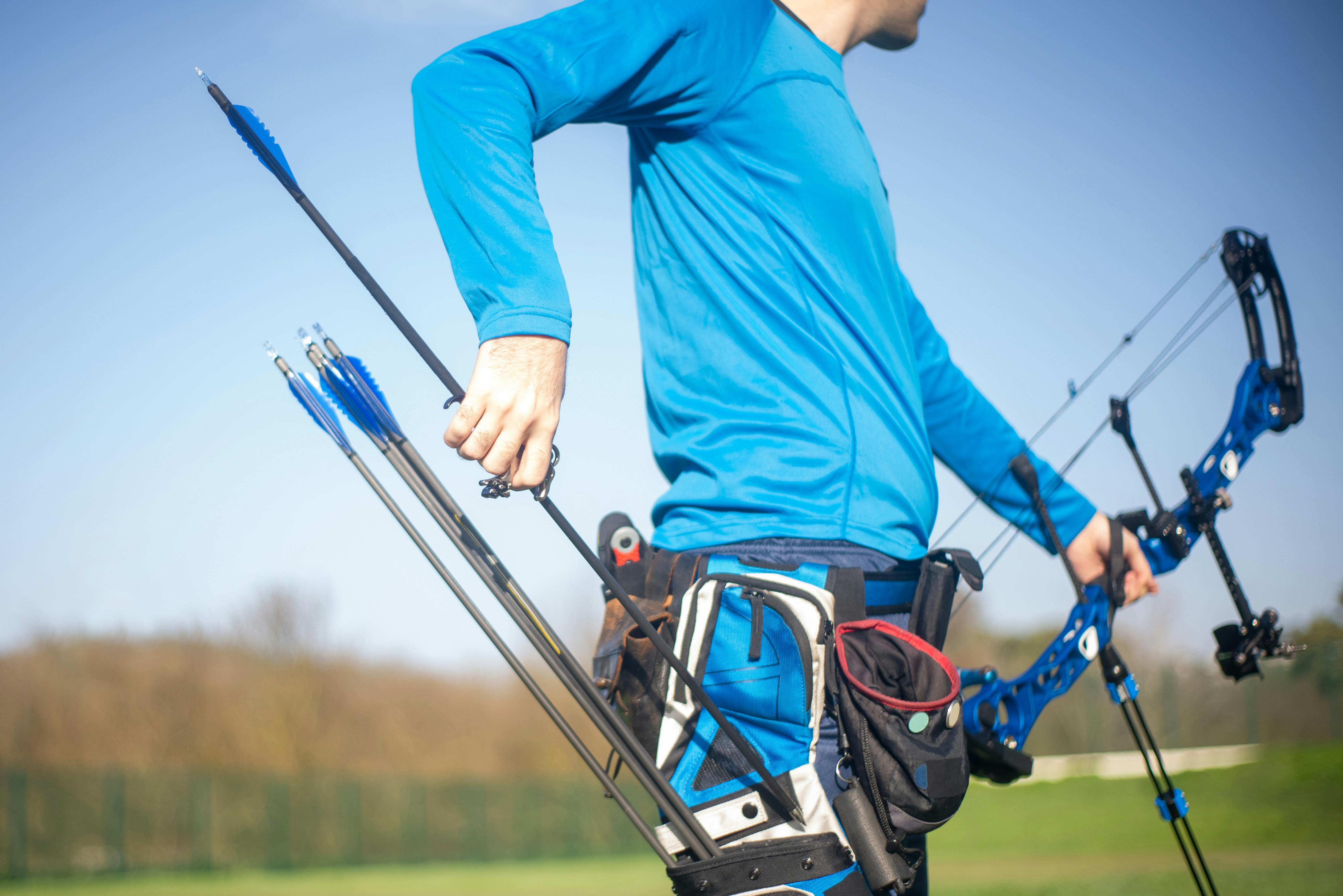 A Person Using a Compound Bow · Free Stock Photo