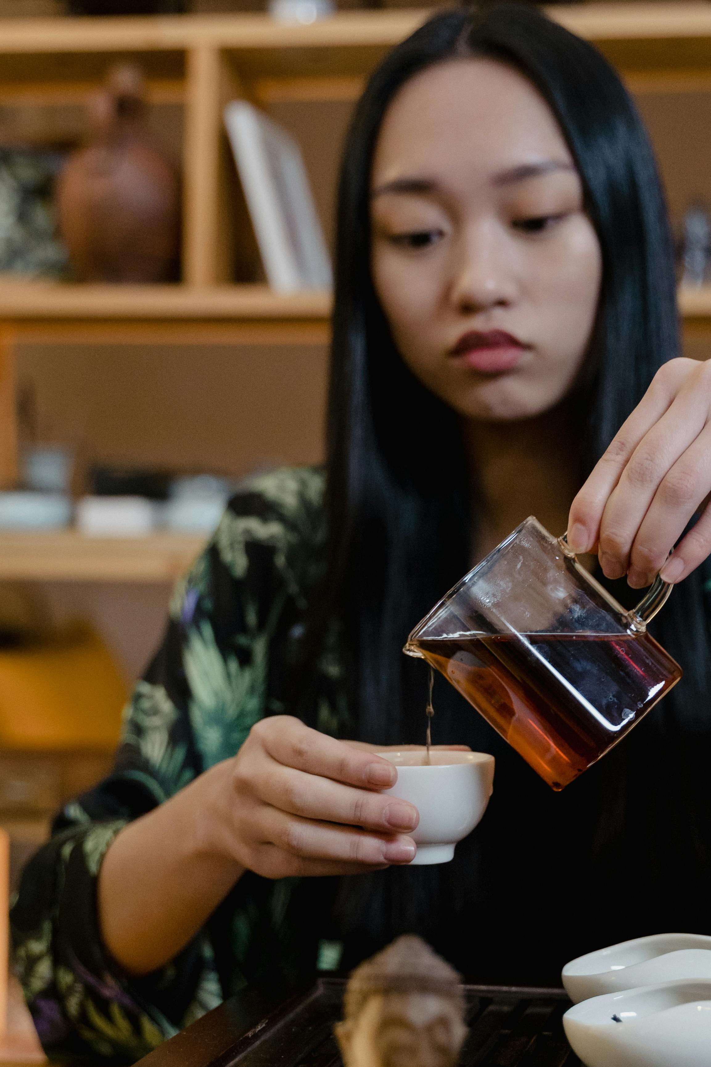 A Woman Pouring Tea · Free Stock Photo
