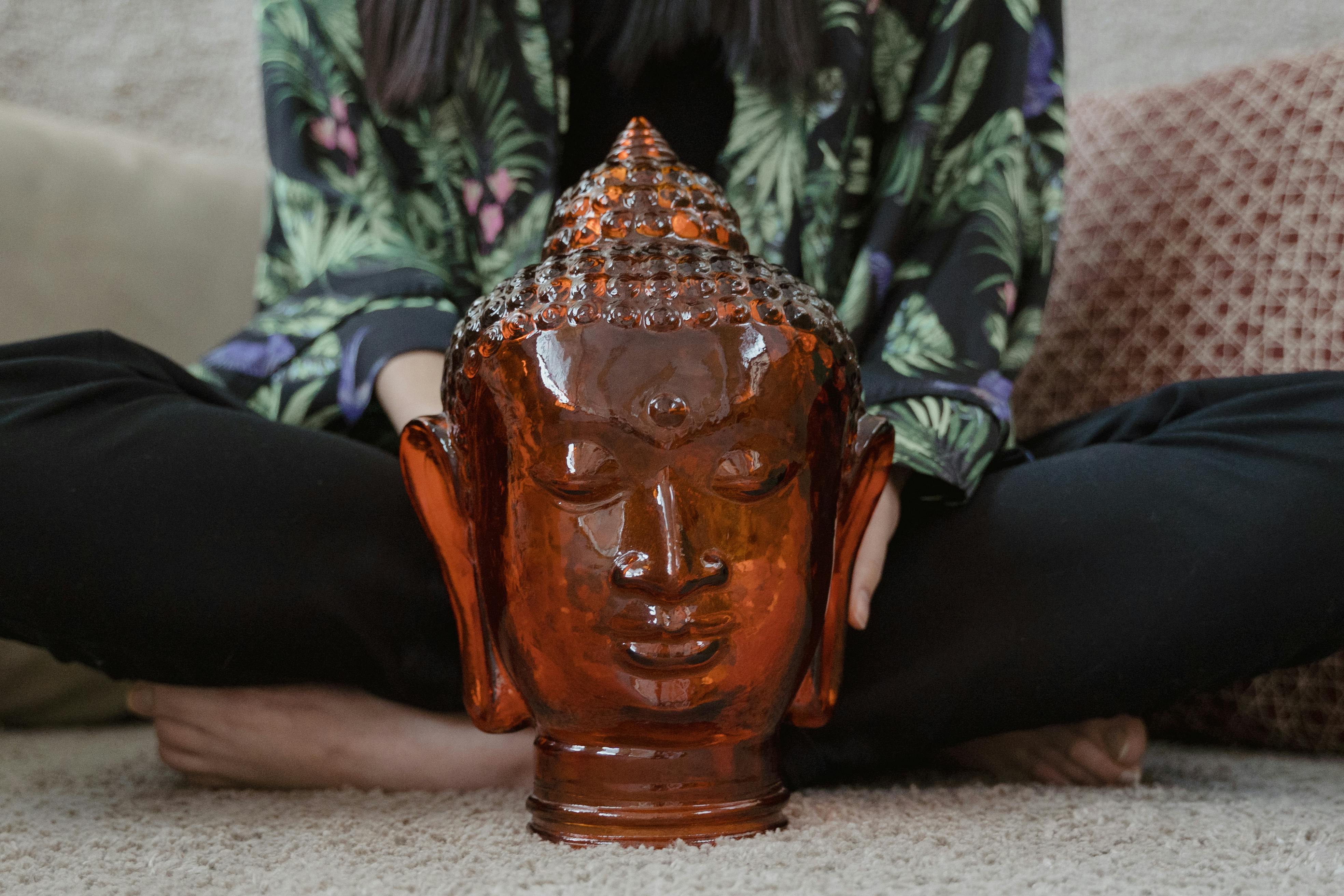A Close-Up Shot of a Glass Buddha Head · Free Stock Photo
