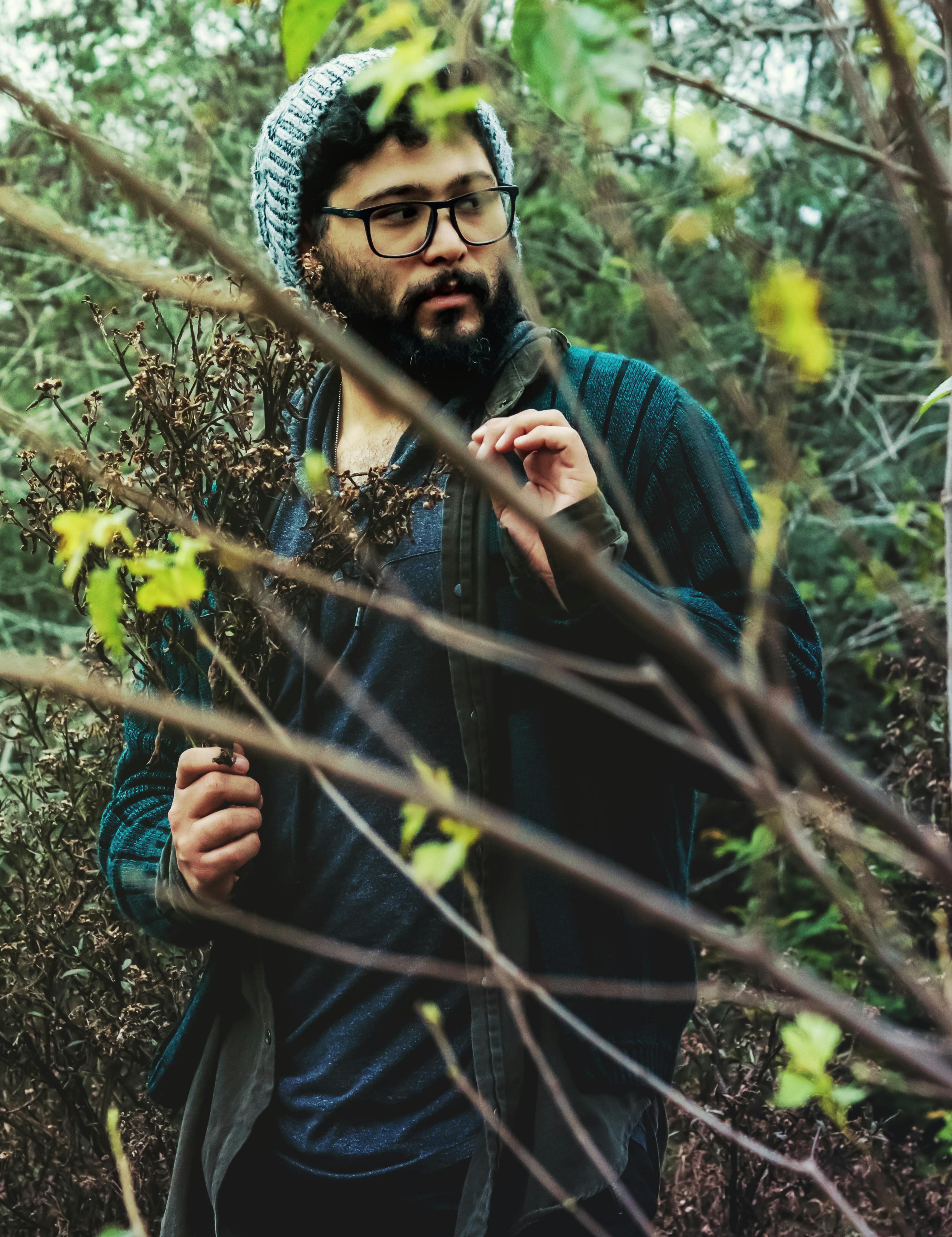 Man surrounded by Tree Branches · Free Stock Photo