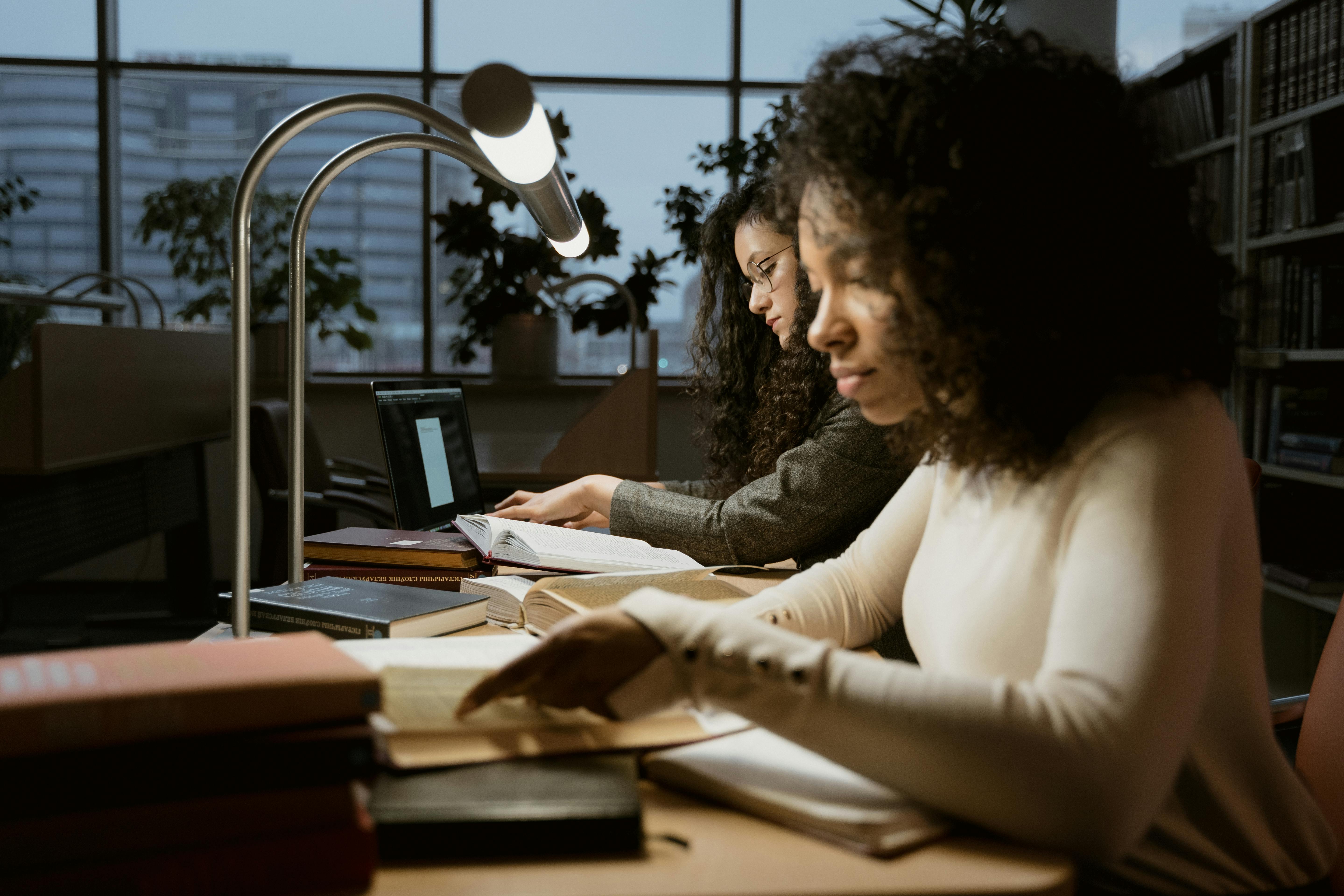 Women Reading Books on the Desk · Free Stock Photo