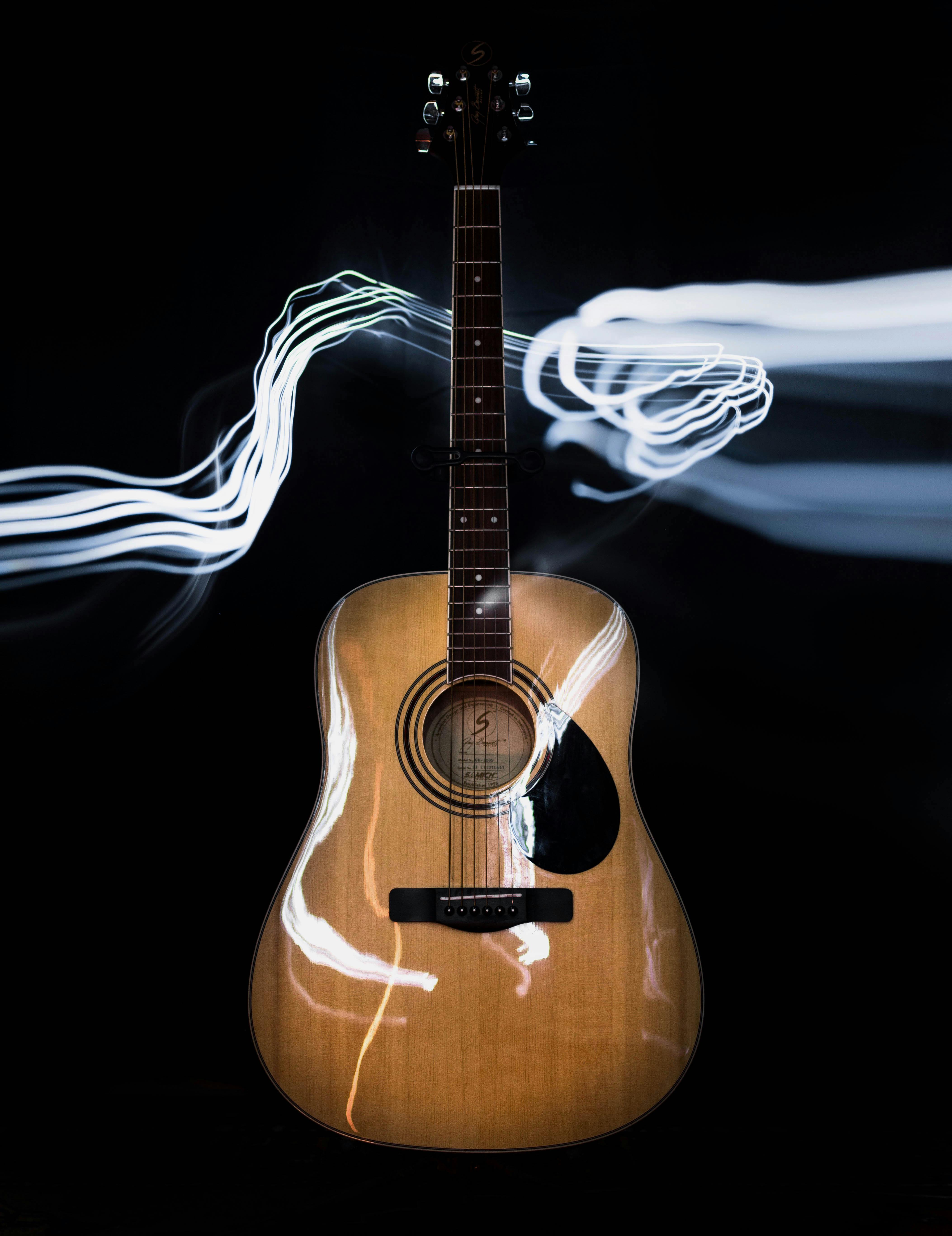 Brown Acoustic Guitar on Black Background · Free Stock Photo