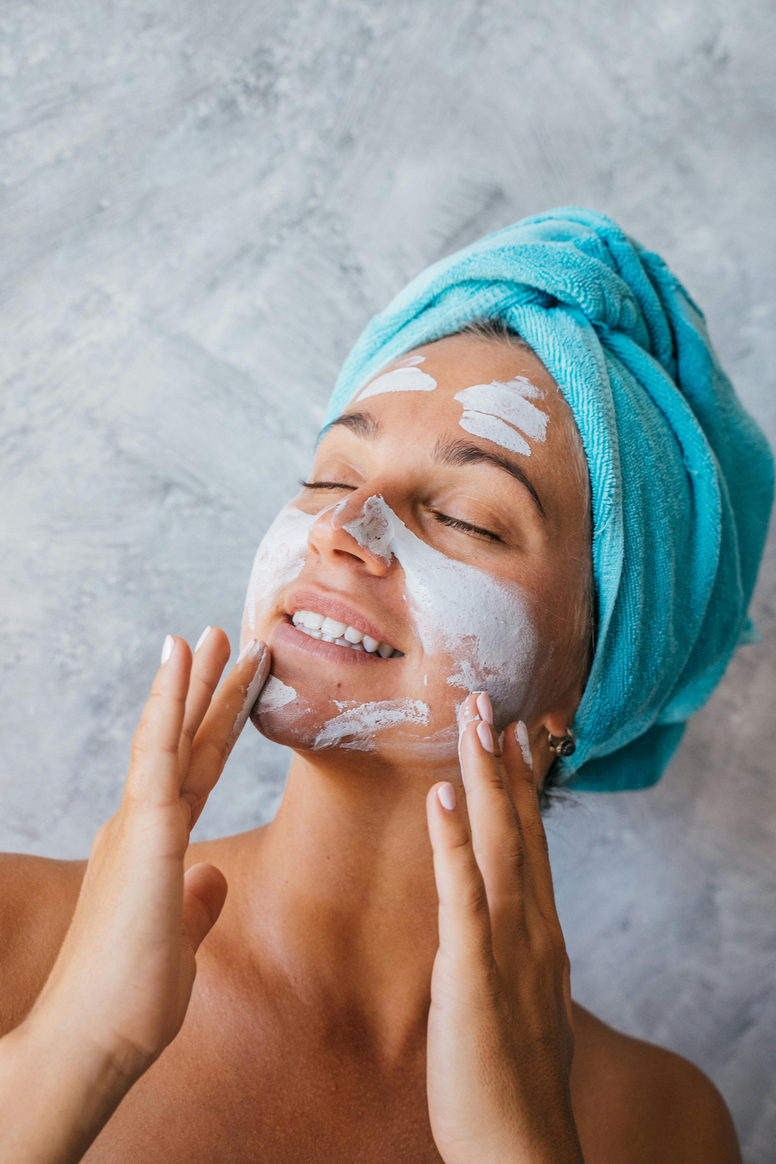 Woman Applying Facial Mask · Free Stock Photo