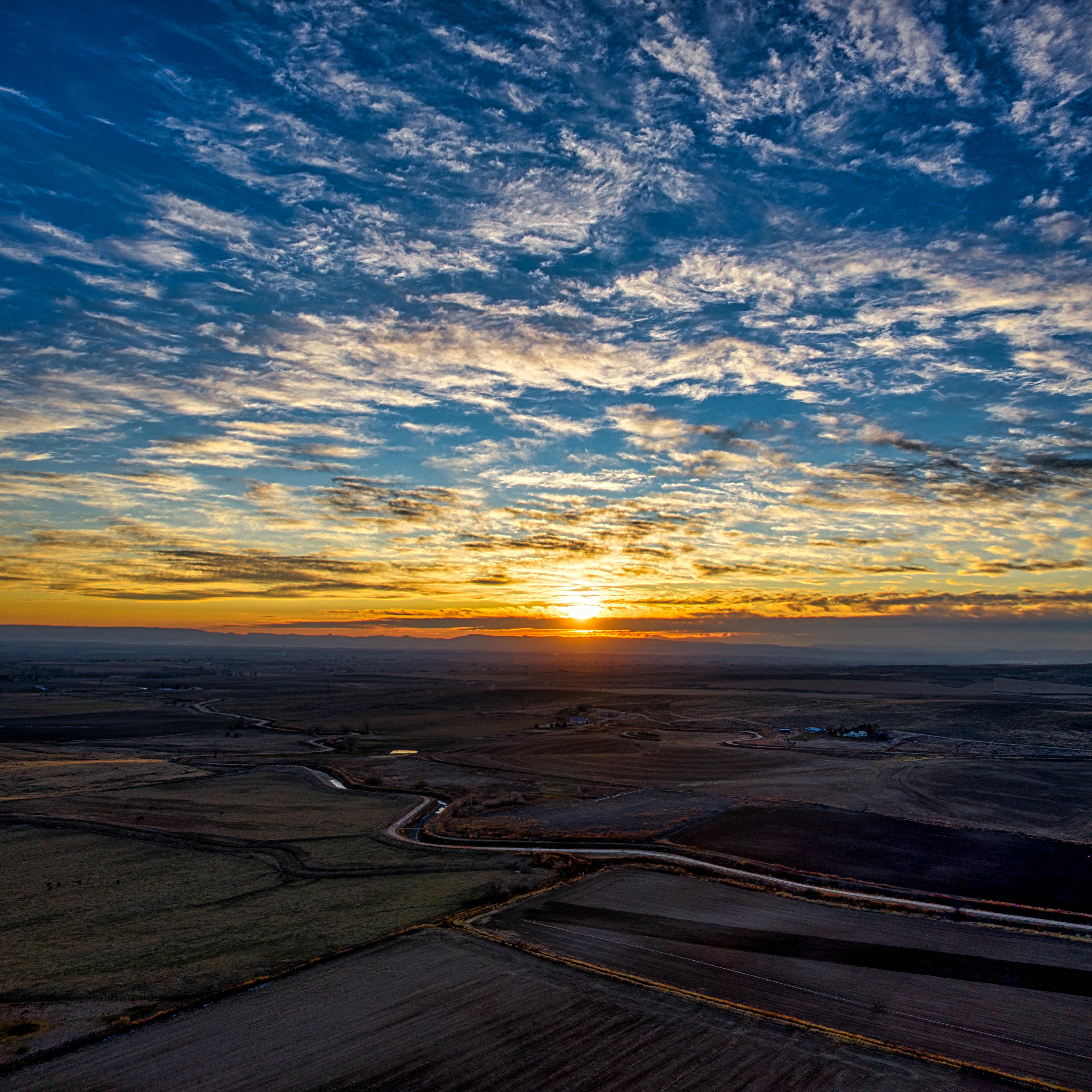 Sun Setting Over Fields · Free Stock Photo
