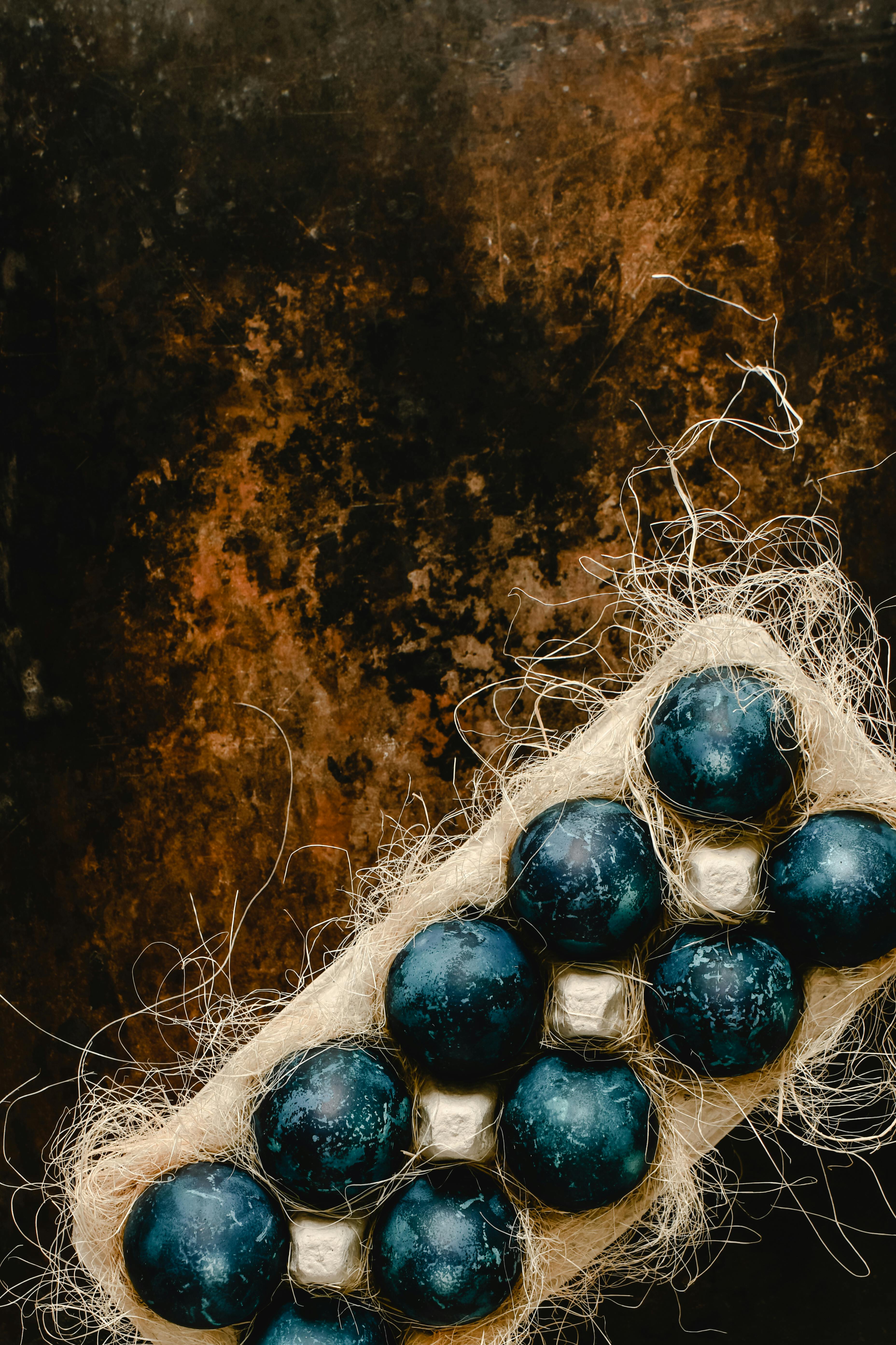 Box of Navy Blue Eggs on a Rusty Countertop · Free Stock Photo