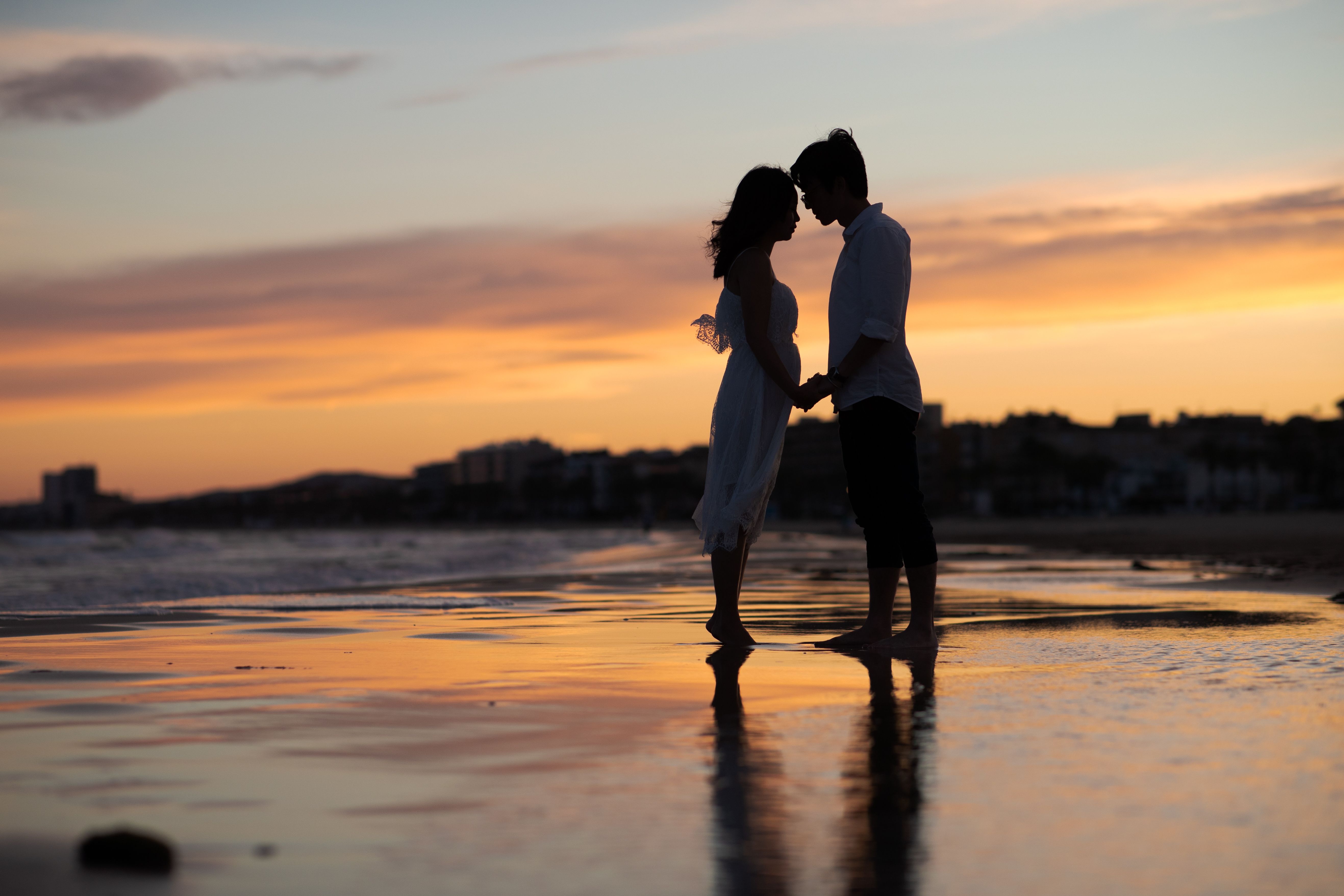 Couple on Beach at Sunset · Free Stock Photo