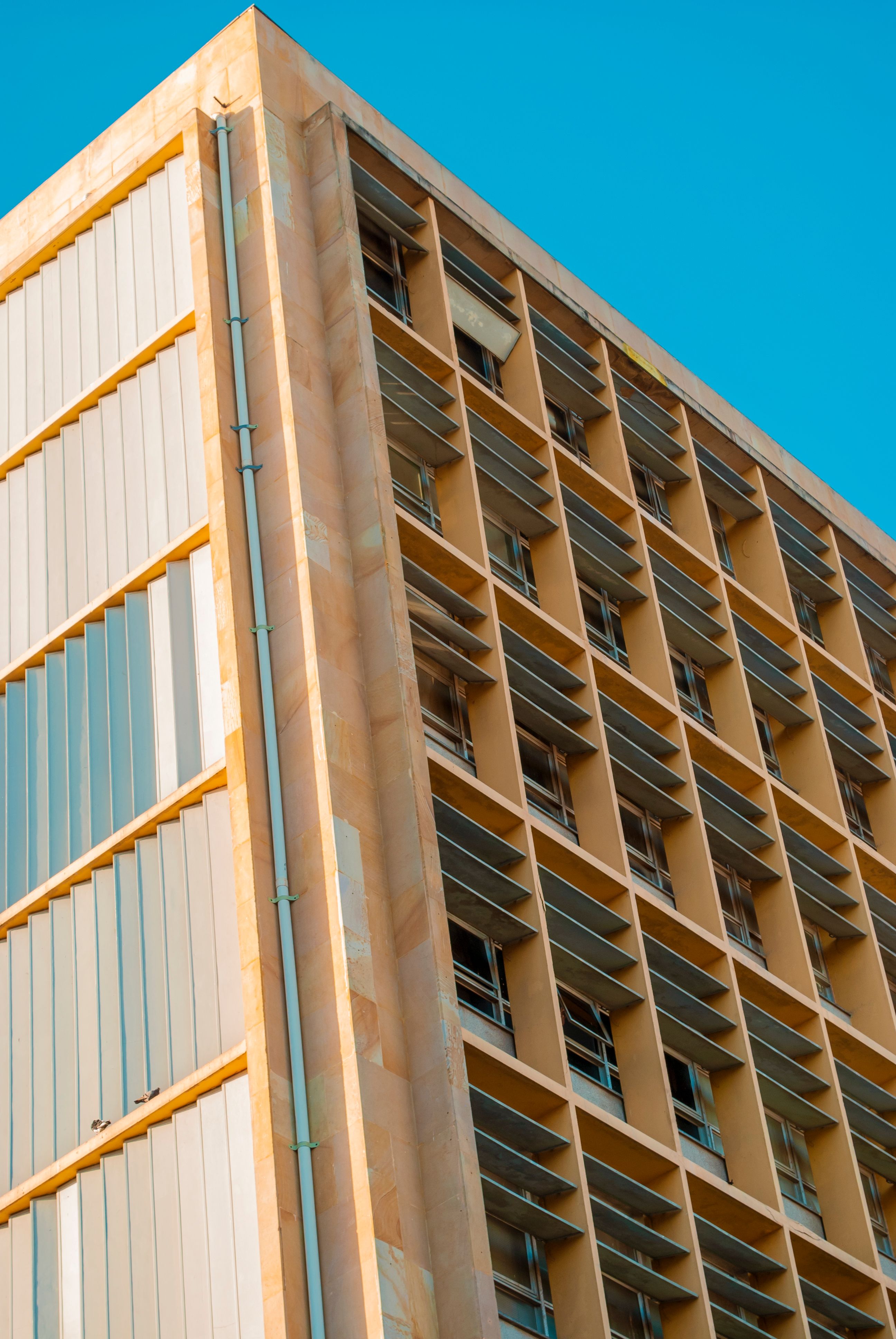 Gray High Rise Building with White Framed Windows · Free Stock Photo