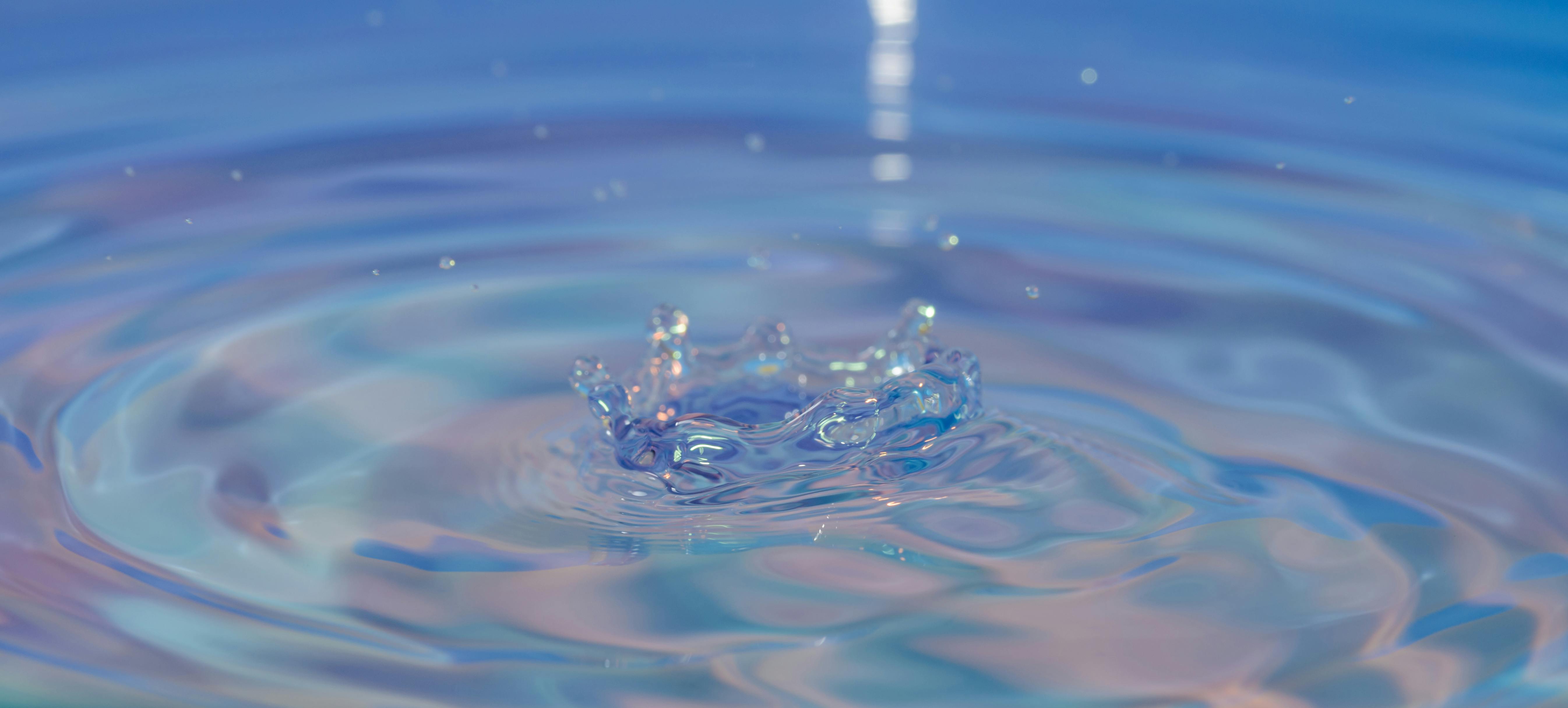 Close-up of Water Splashing Against Black Background · Free Stock Photo