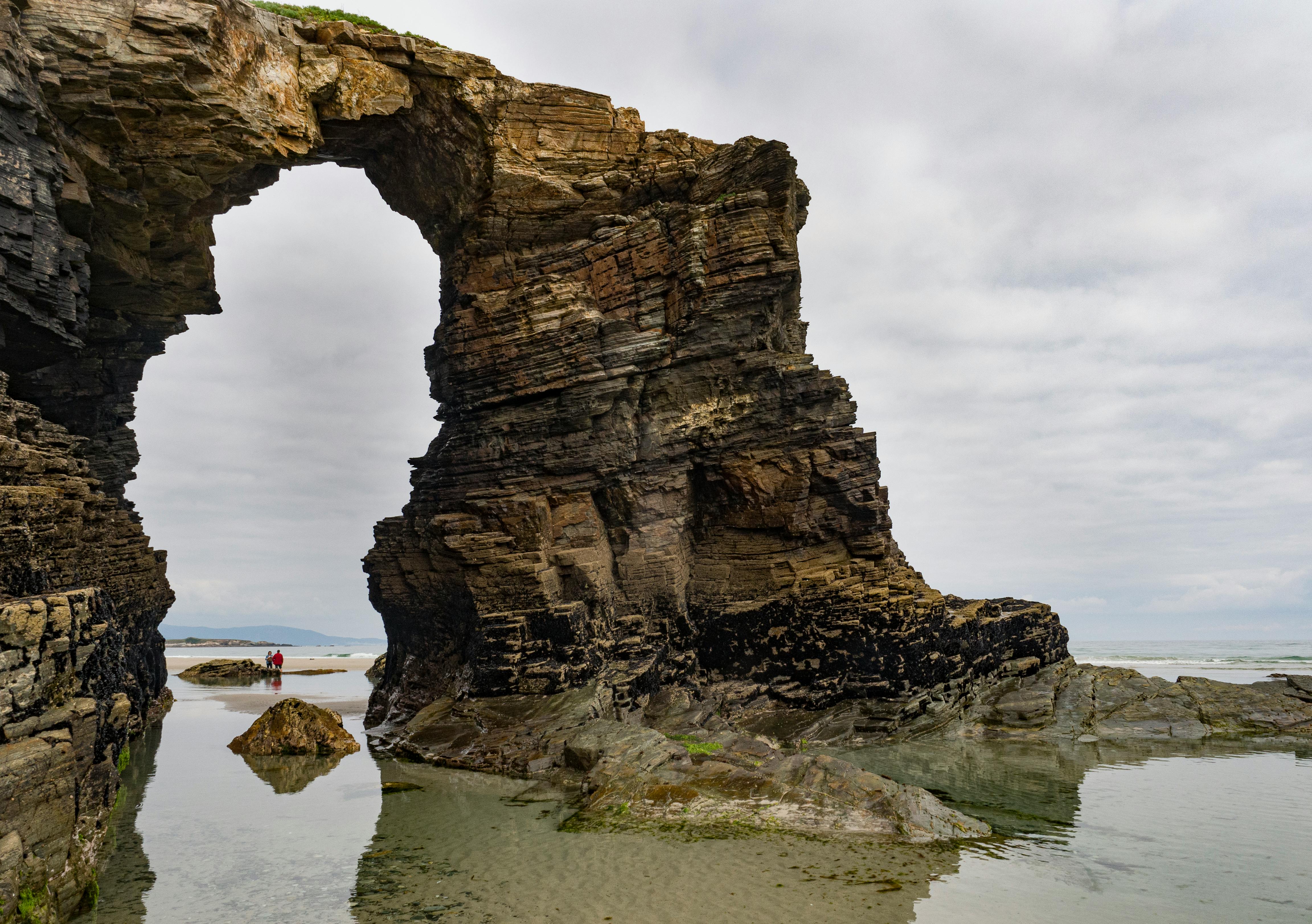 Rocks Forming Arch on Beach · Free Stock Photo