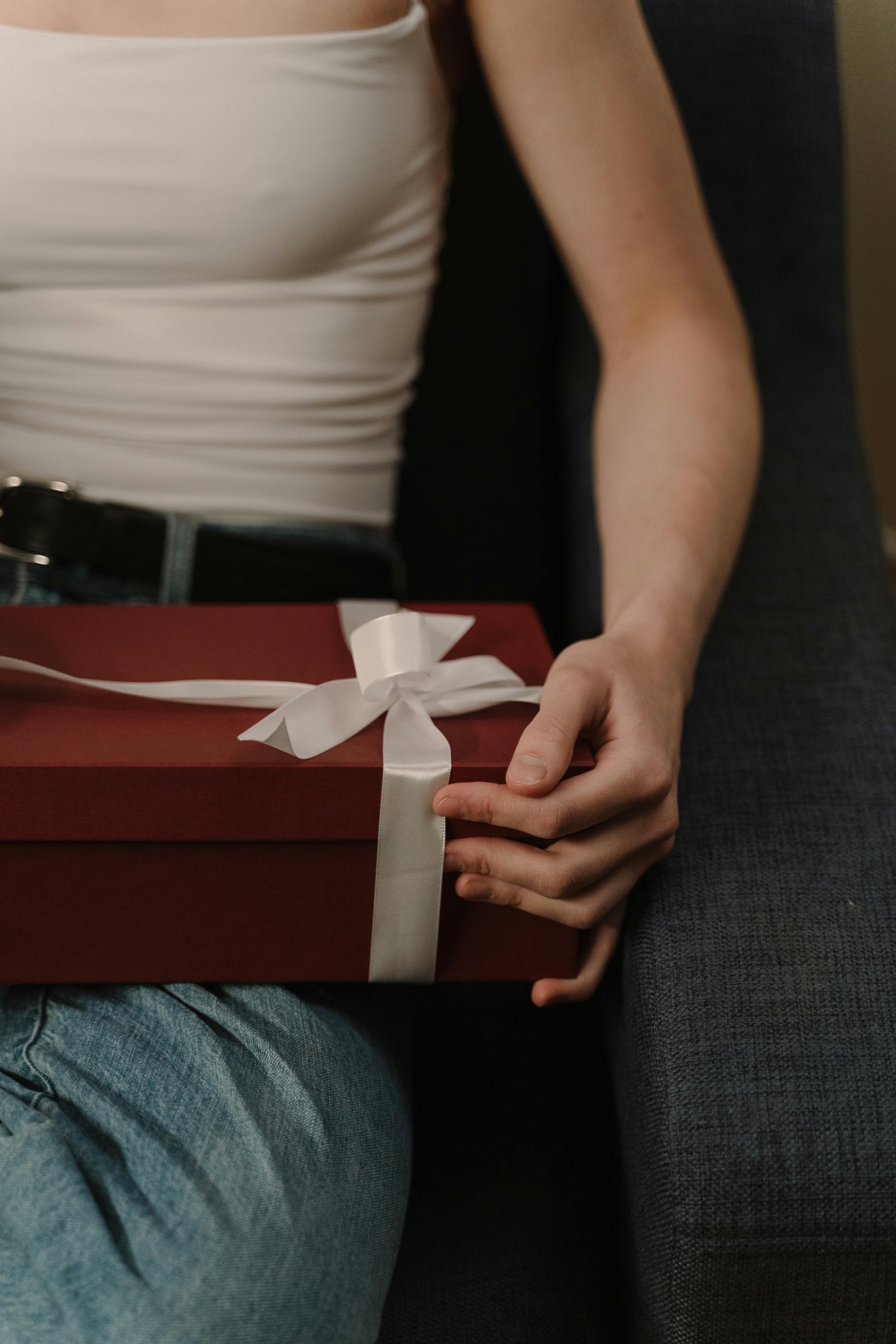 Person Holding a Box with Ribbon · Free Stock Photo
