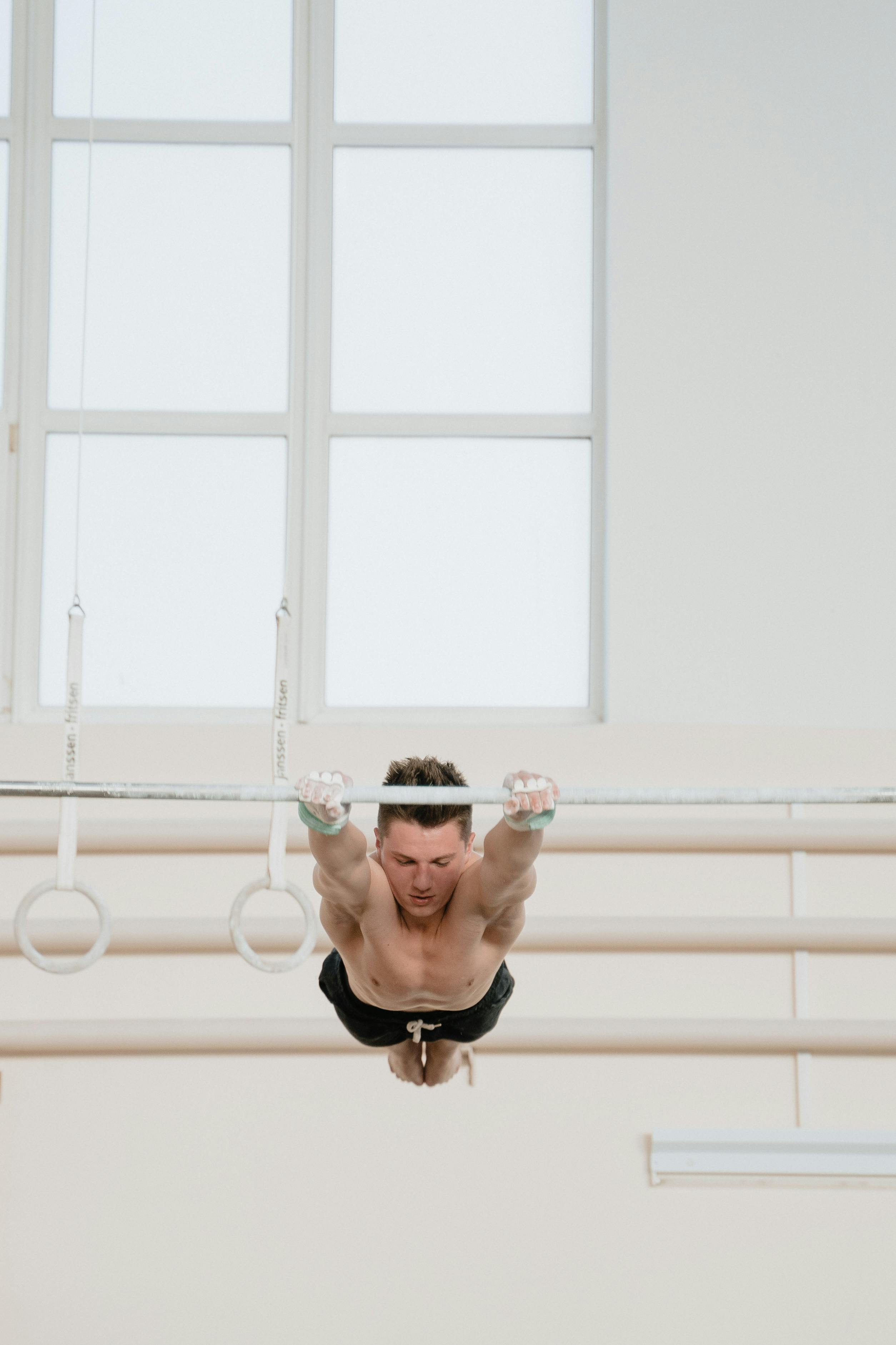 A Man Doing Gymnastics on a Parallel Bar · Free Stock Photo
