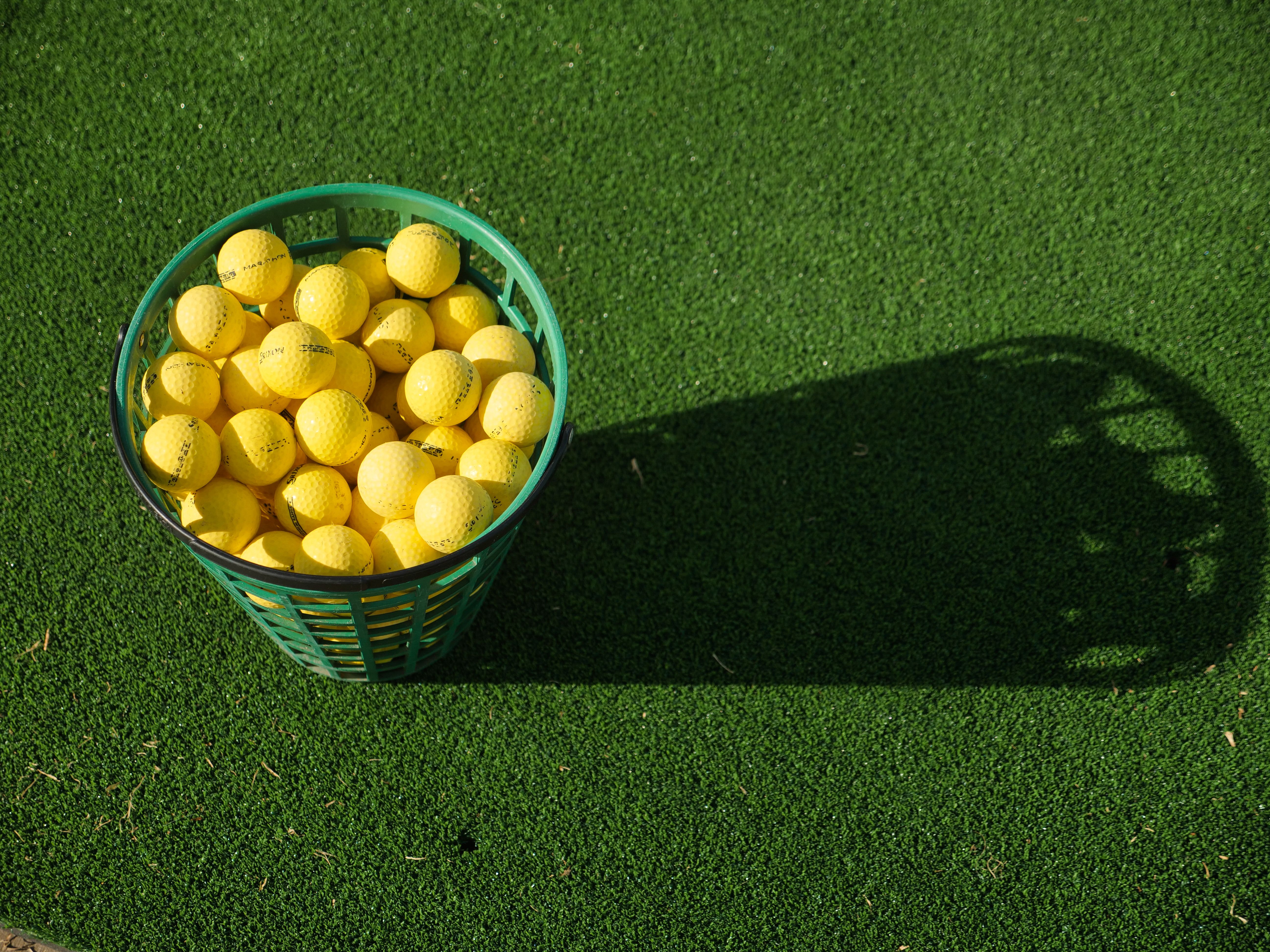 Photo of Yellow Golf Balls in Green Basket · Free Stock Photo