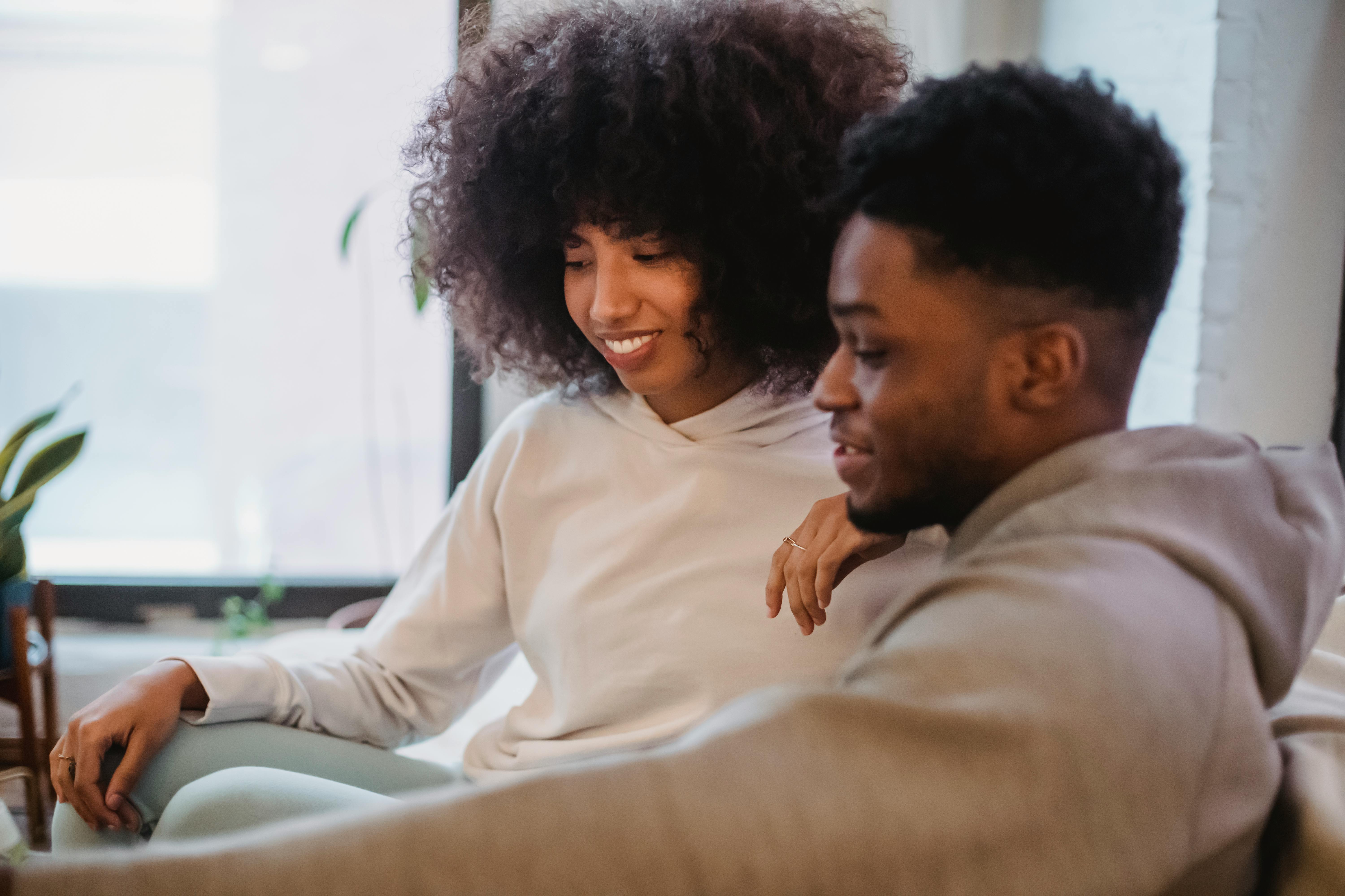 Cheerful black couple entertaining together at home · Free Stock Photo