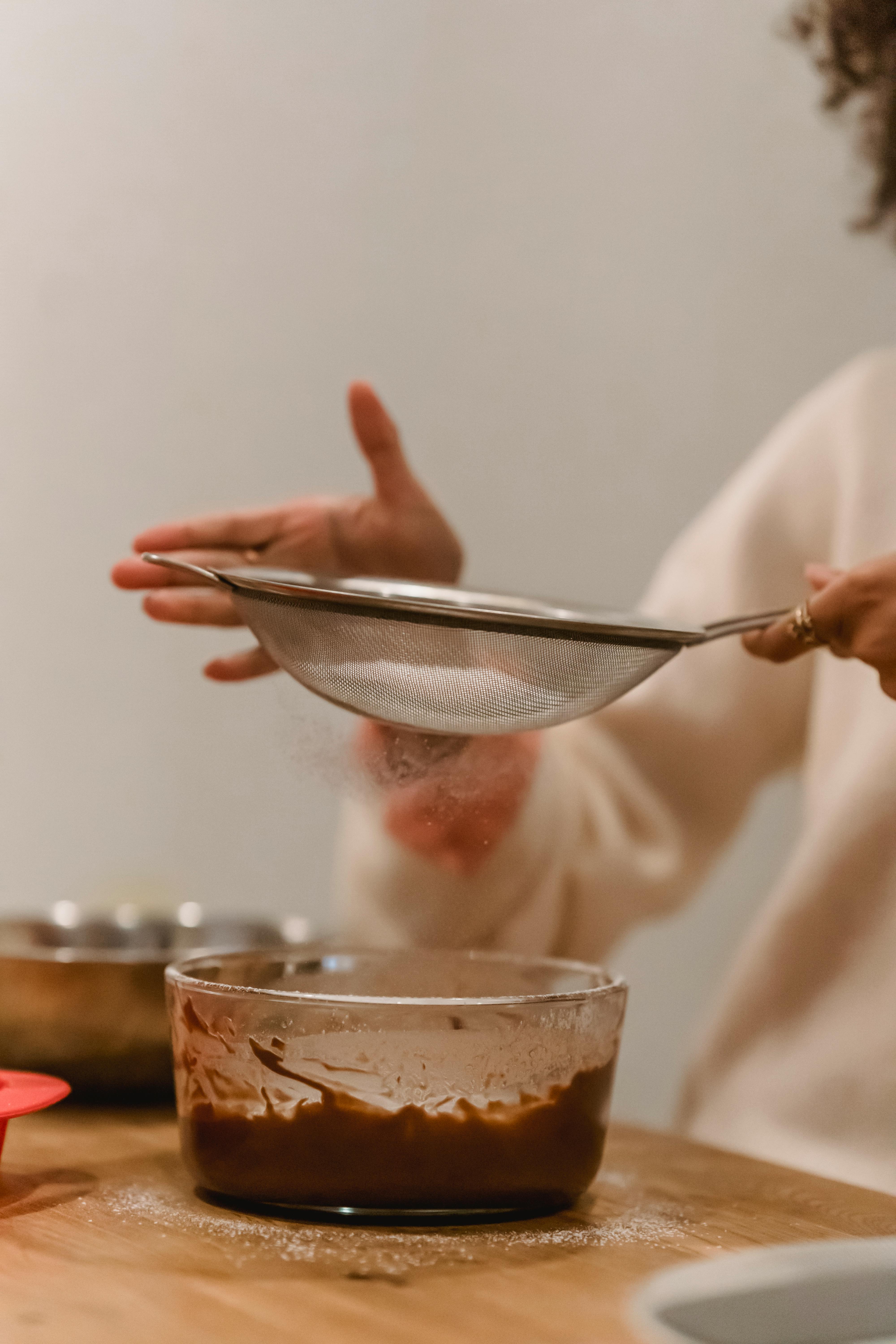 Crop woman adding flour into batter · Free Stock Photo