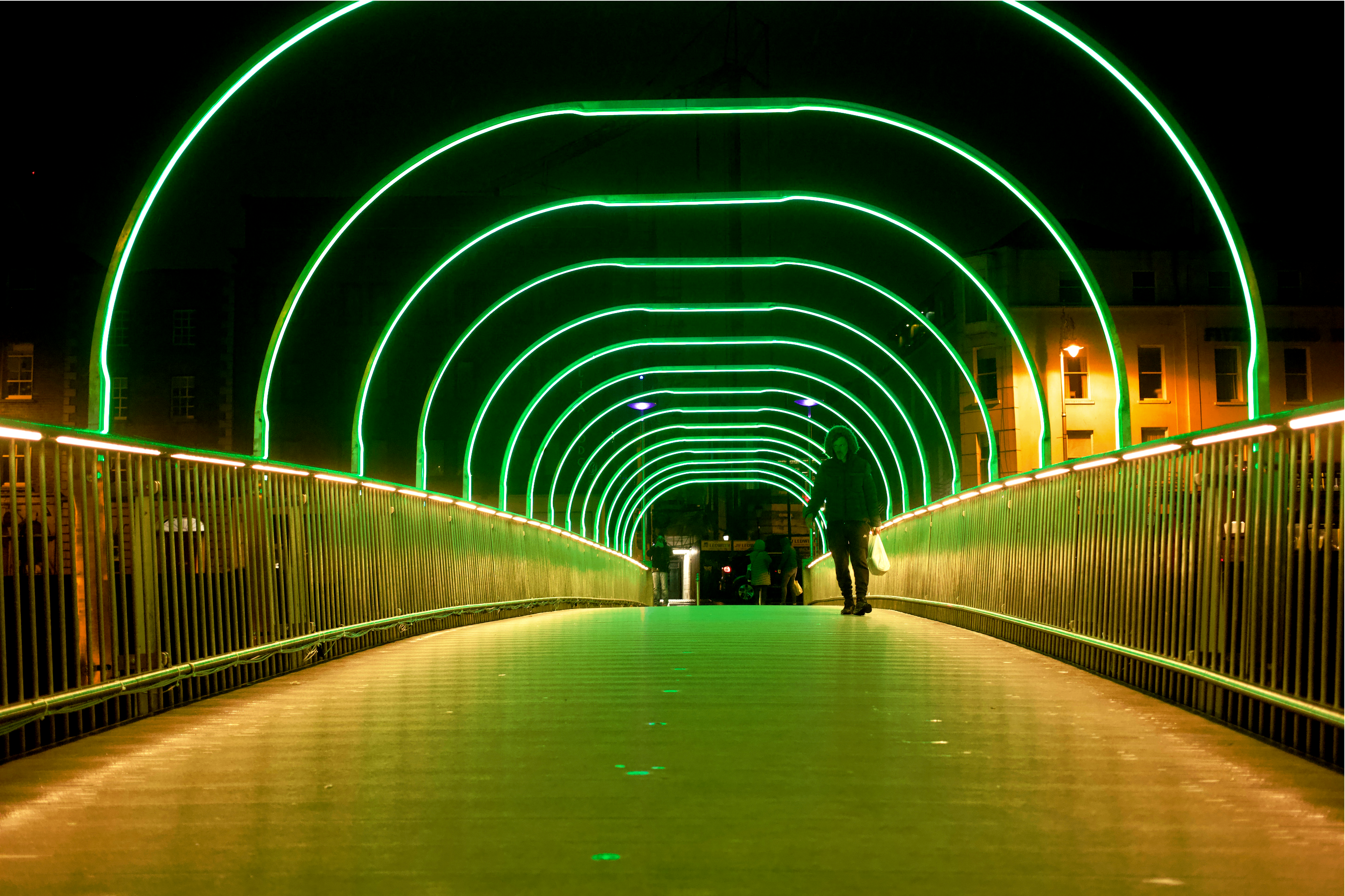 Man Walking on the Bridge with Neon Lights · Free Stock Photo