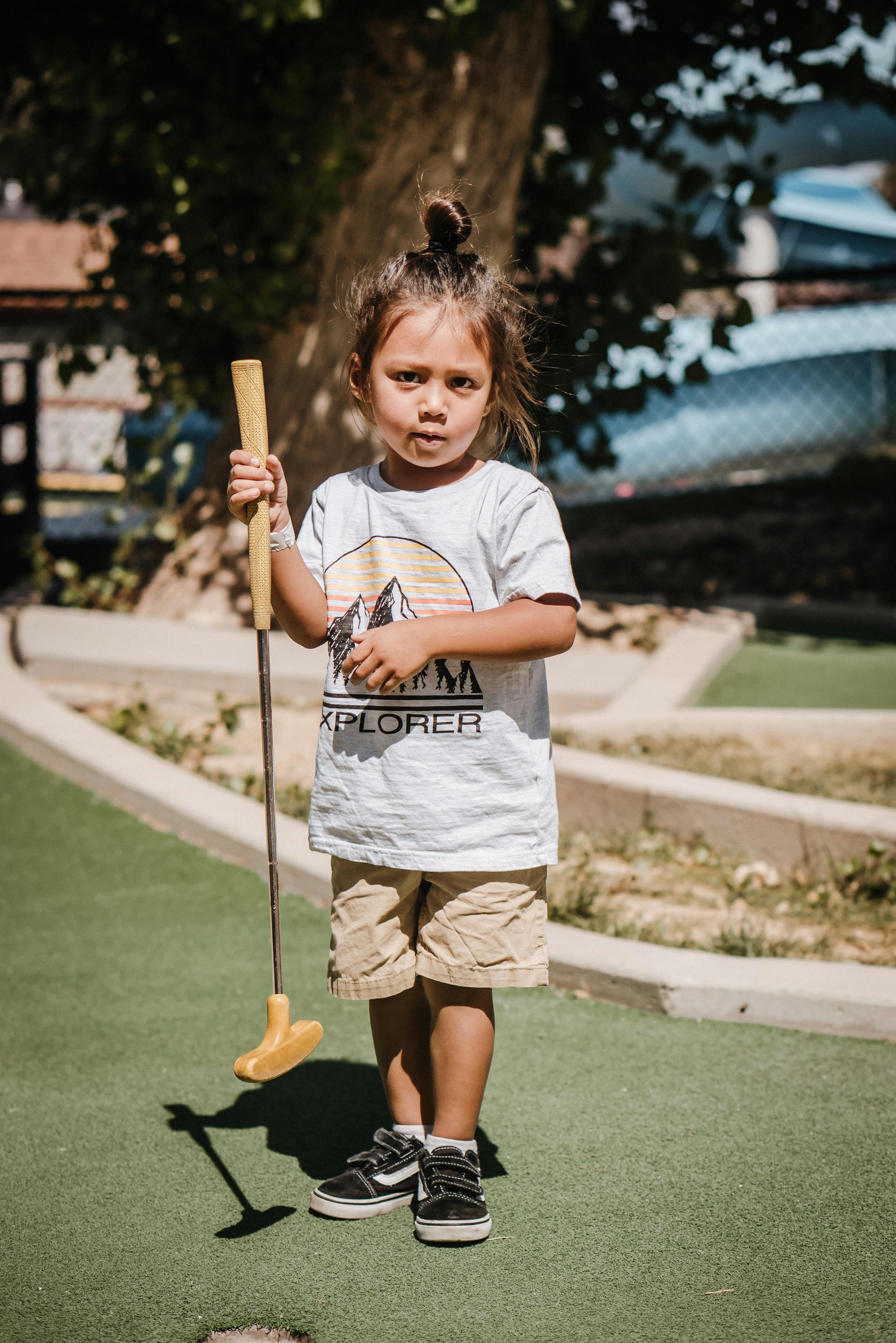 A Boy Playing Mini Golf · Free Stock Photo