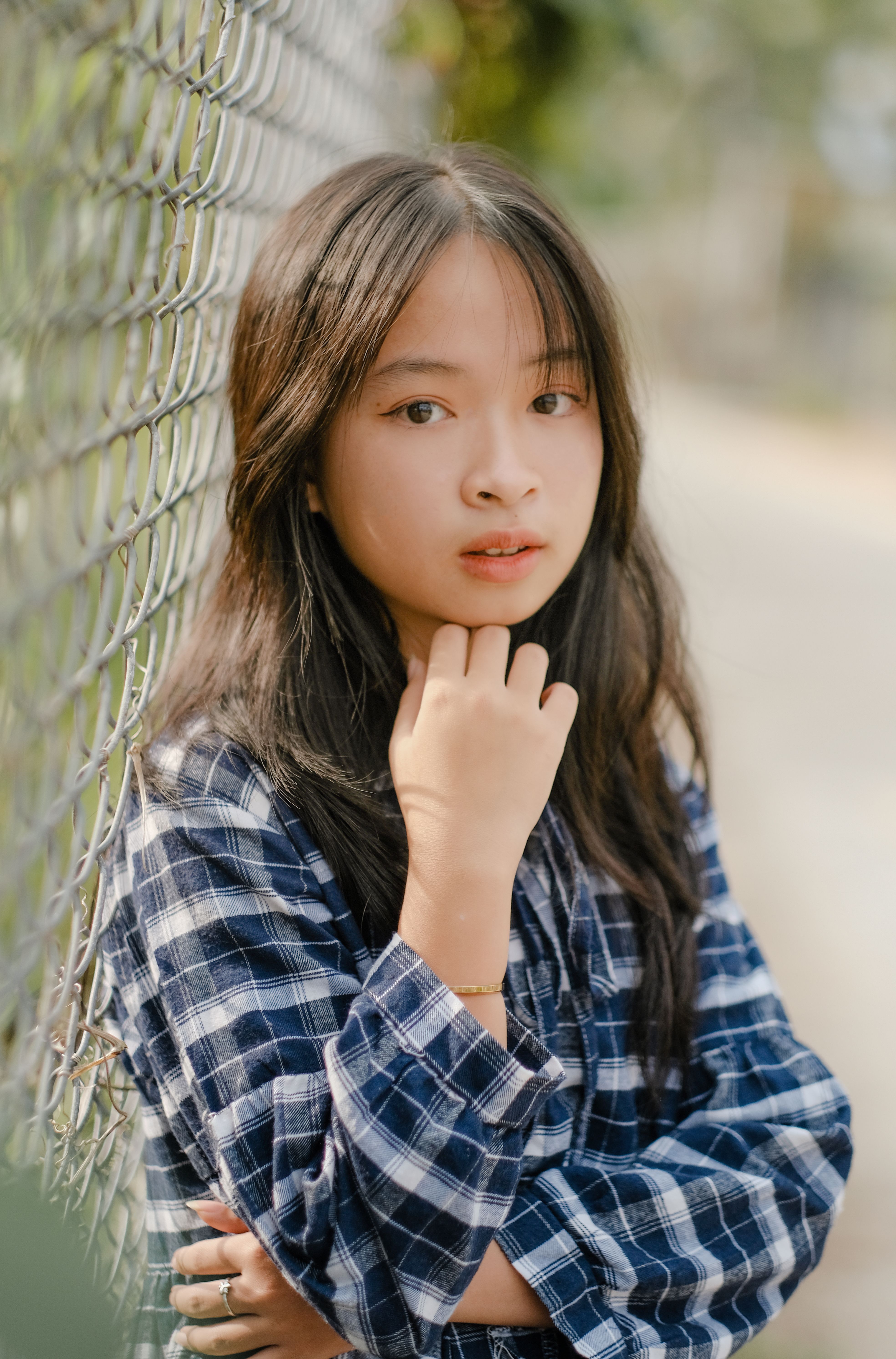 Cute Asian girl touching chin standing near net · Free Stock Photo