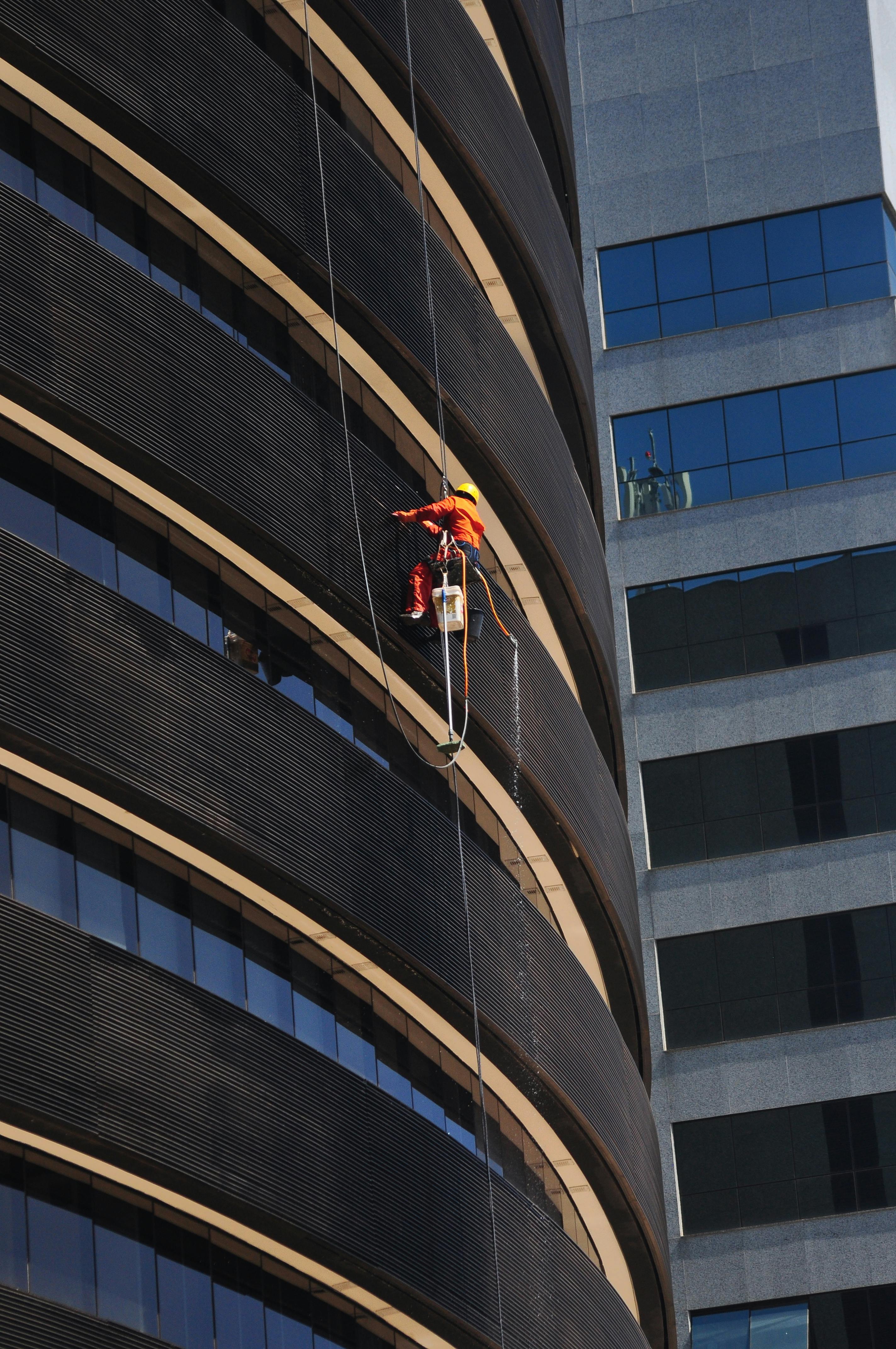 Photo Of Man Cleaning The Building During Daytime · Free Stock Photo