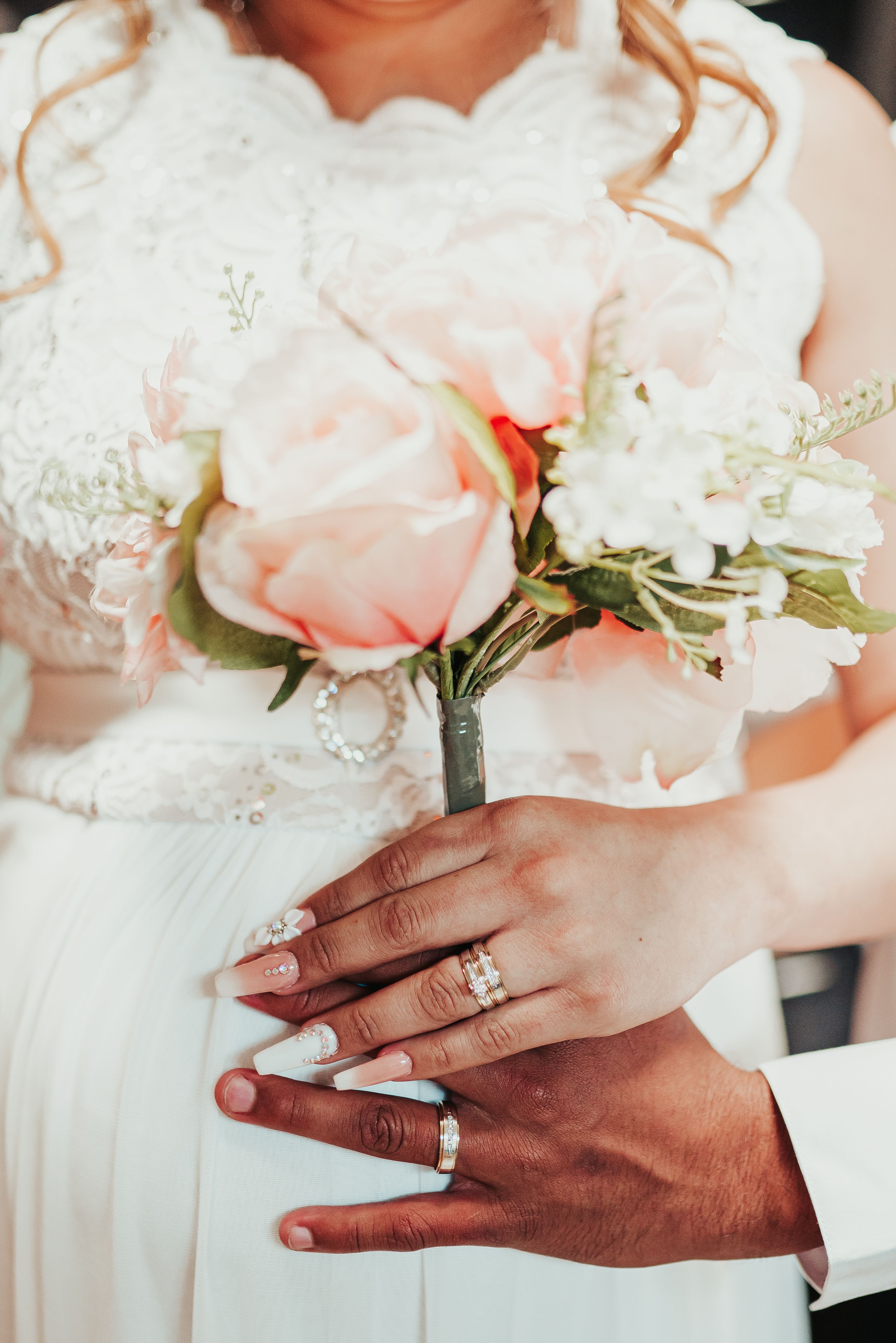 A Close-Up Shot of Newlyweds Holding Hands · Free Stock Photo