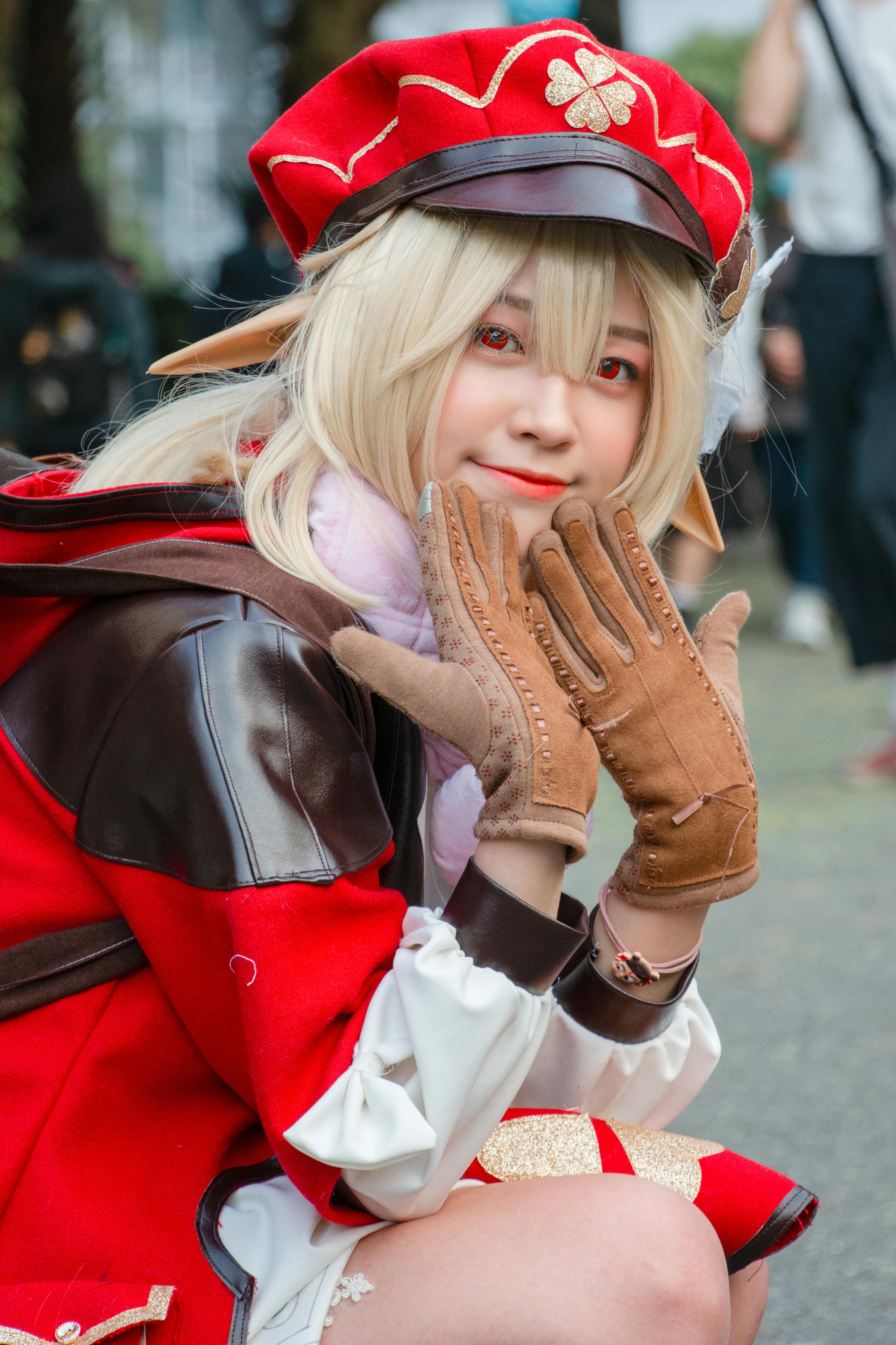 A Cute Cosplayer in Red Costume Smiling at the Camera · Free Stock Photo