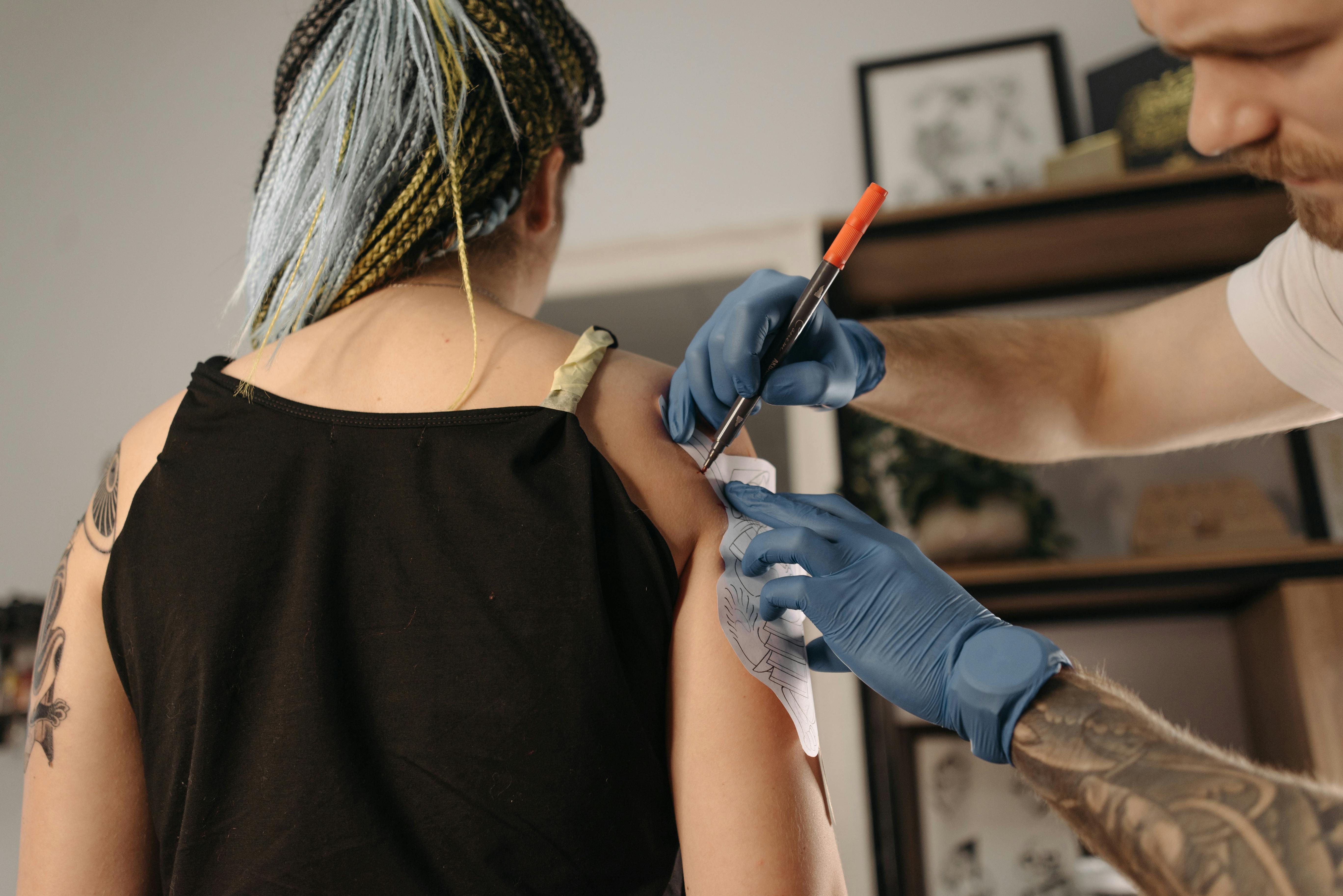 Tattooer Tattooing on Woman Arm · Free Stock Photo