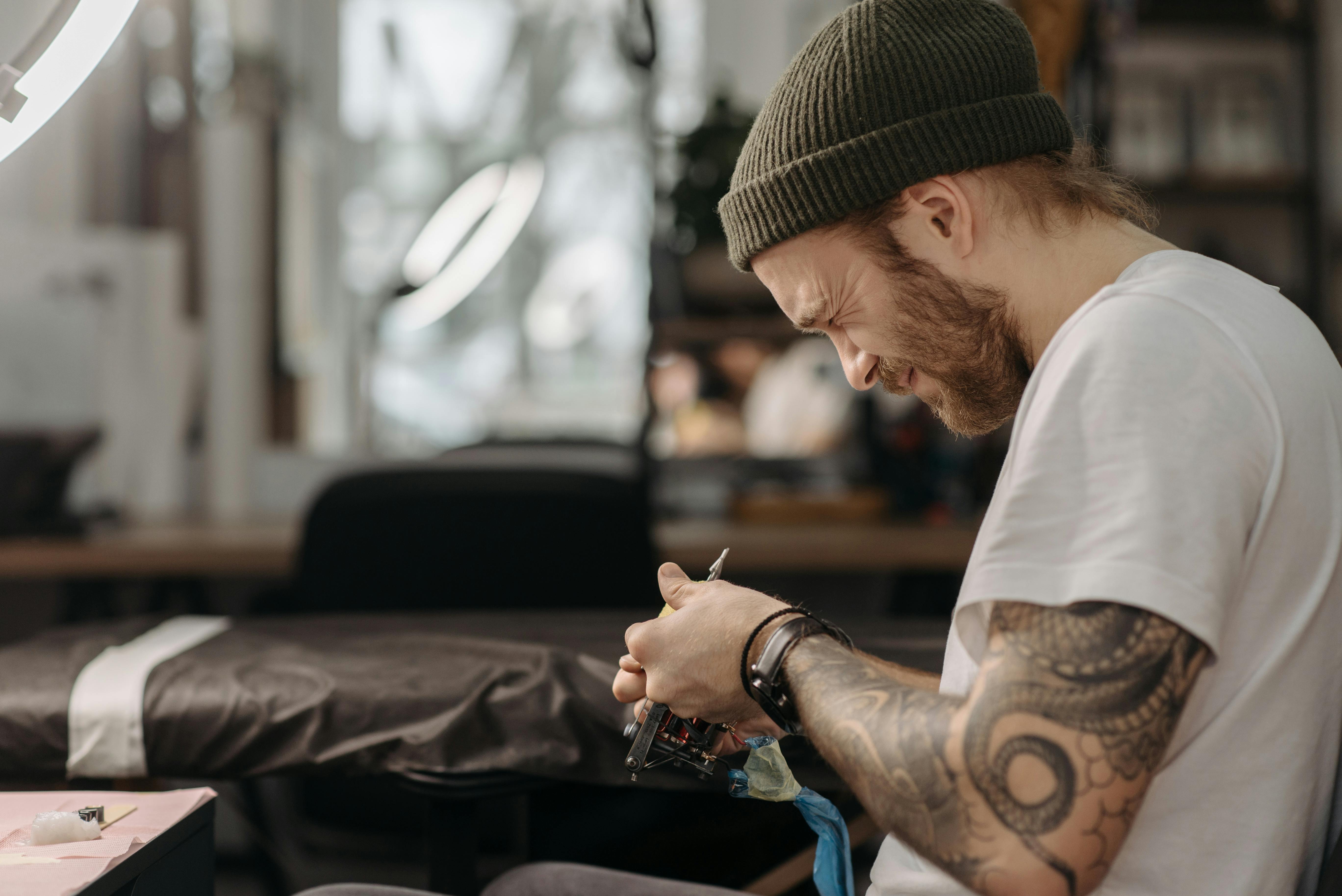 A Tattoo Artist Preparing His Tools · Free Stock Photo