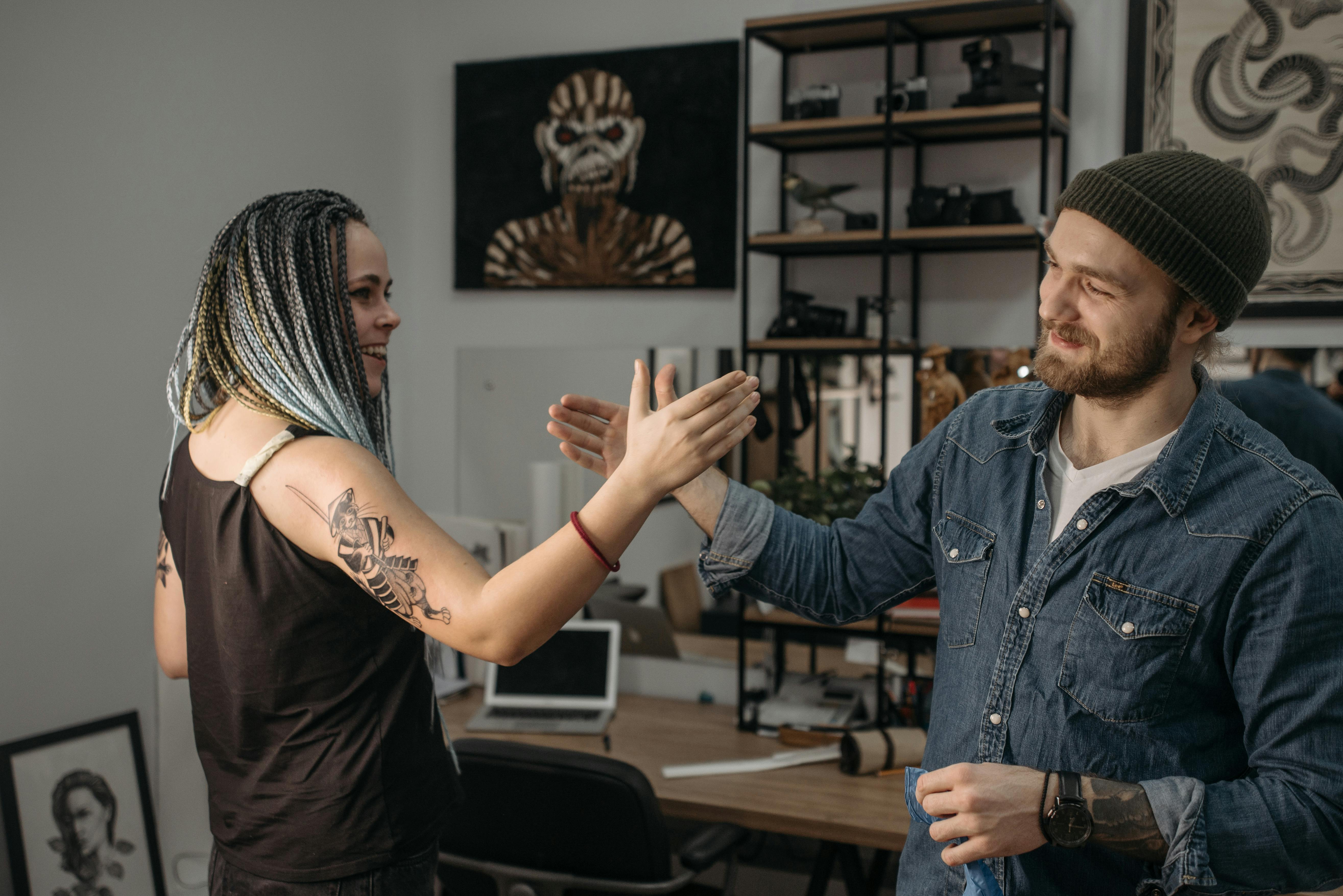Smiling Woman with Tattoo Clapping Hands with Tattooer · Free Stock Photo