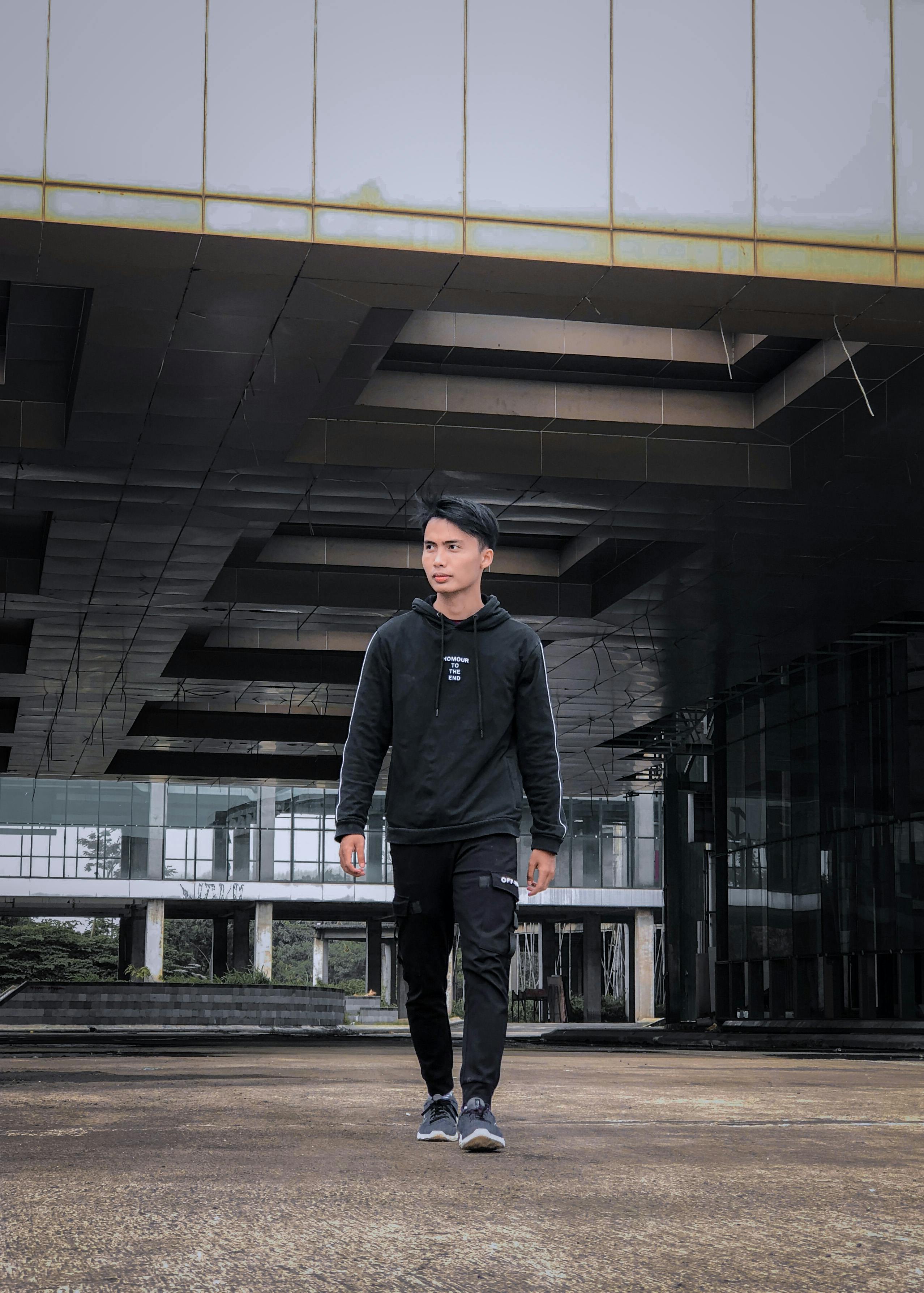 Young Men in Trendy Outfits Standing in a Modern Building · Free Stock ...