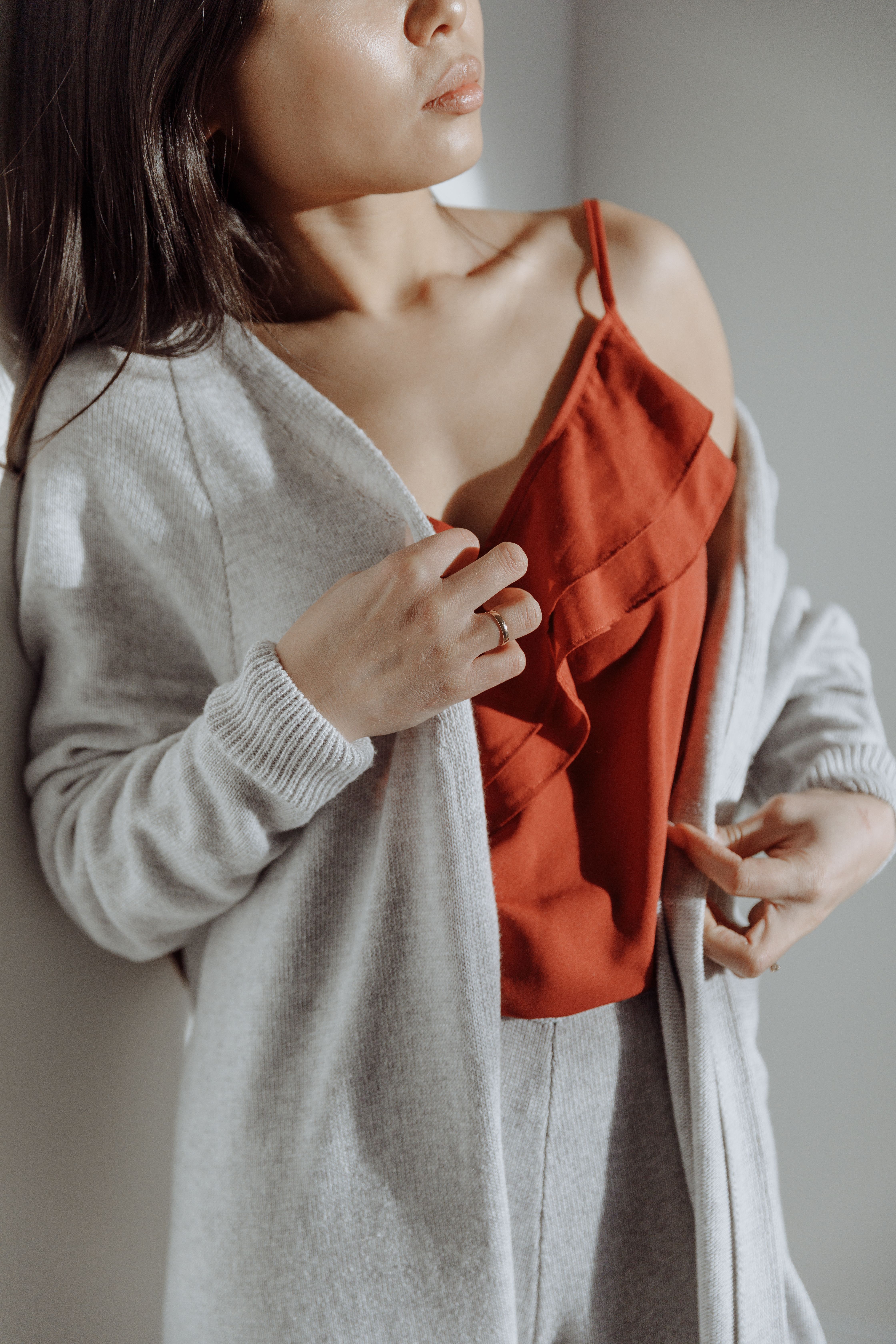 Woman with Hand on Chest Leaning on a Wall · Free Stock Photo