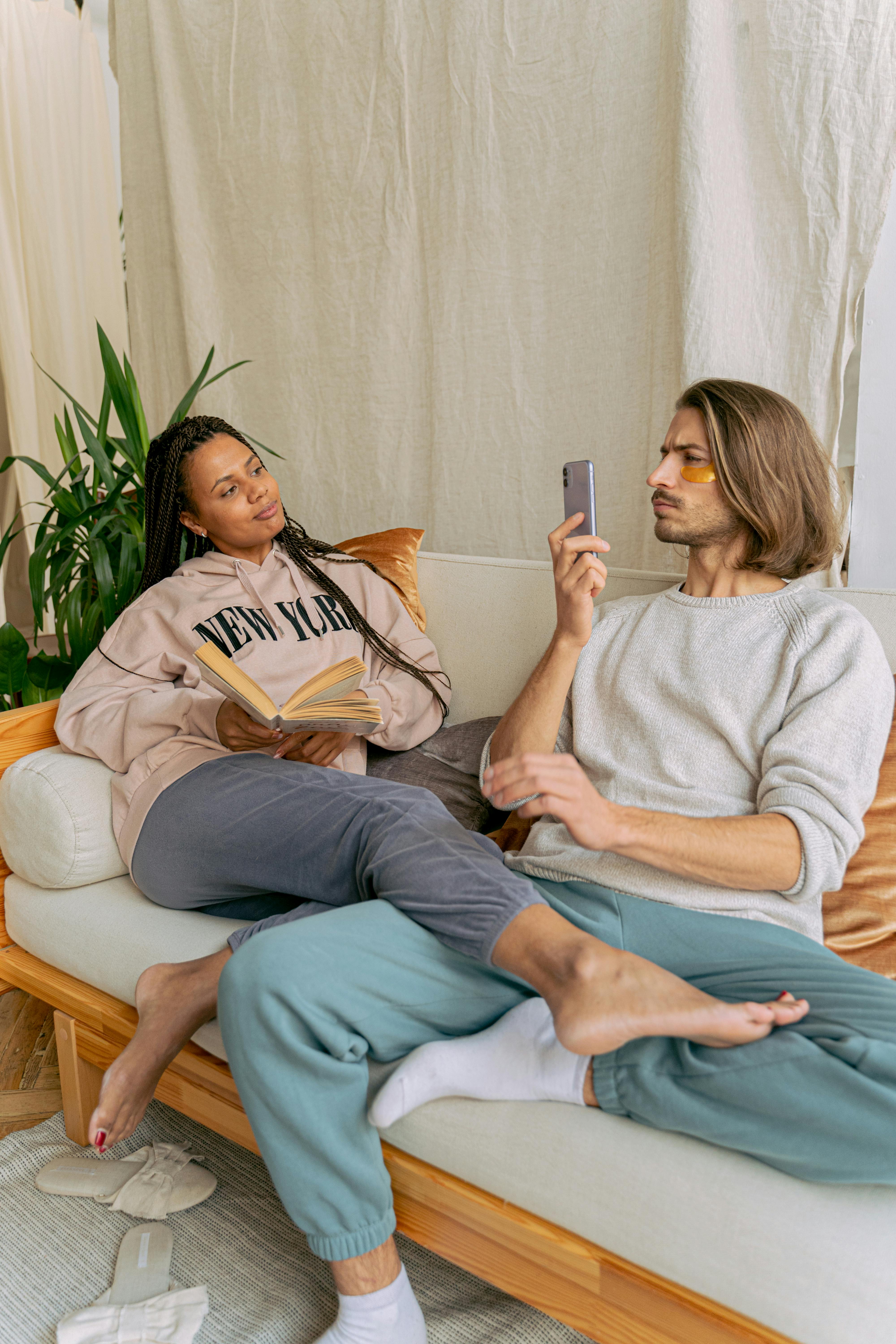 A Couple Sitting Comfortably on a Couch · Free Stock Photo