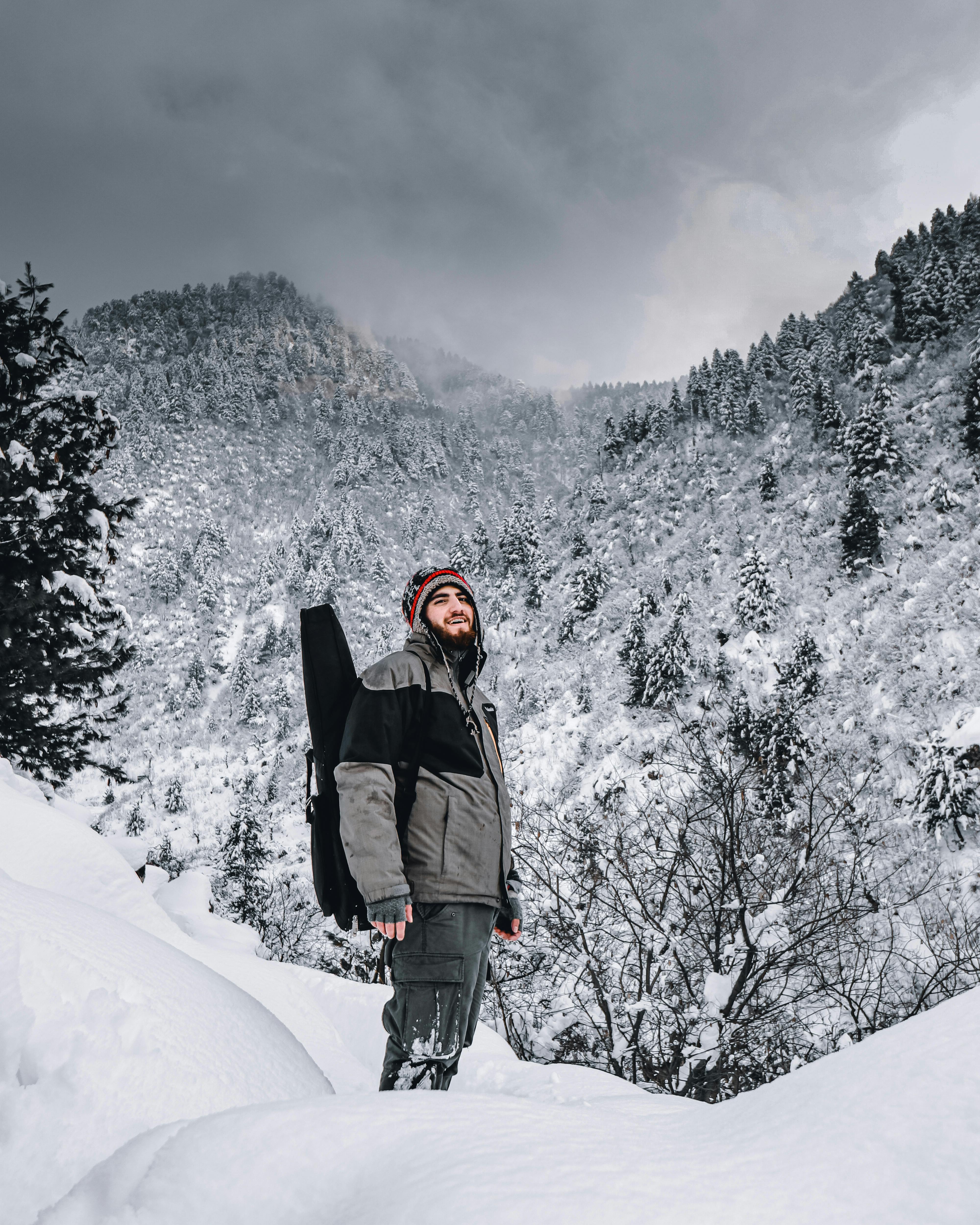 A Man Standing in a Snow Covered Mountain · Free Stock Photo