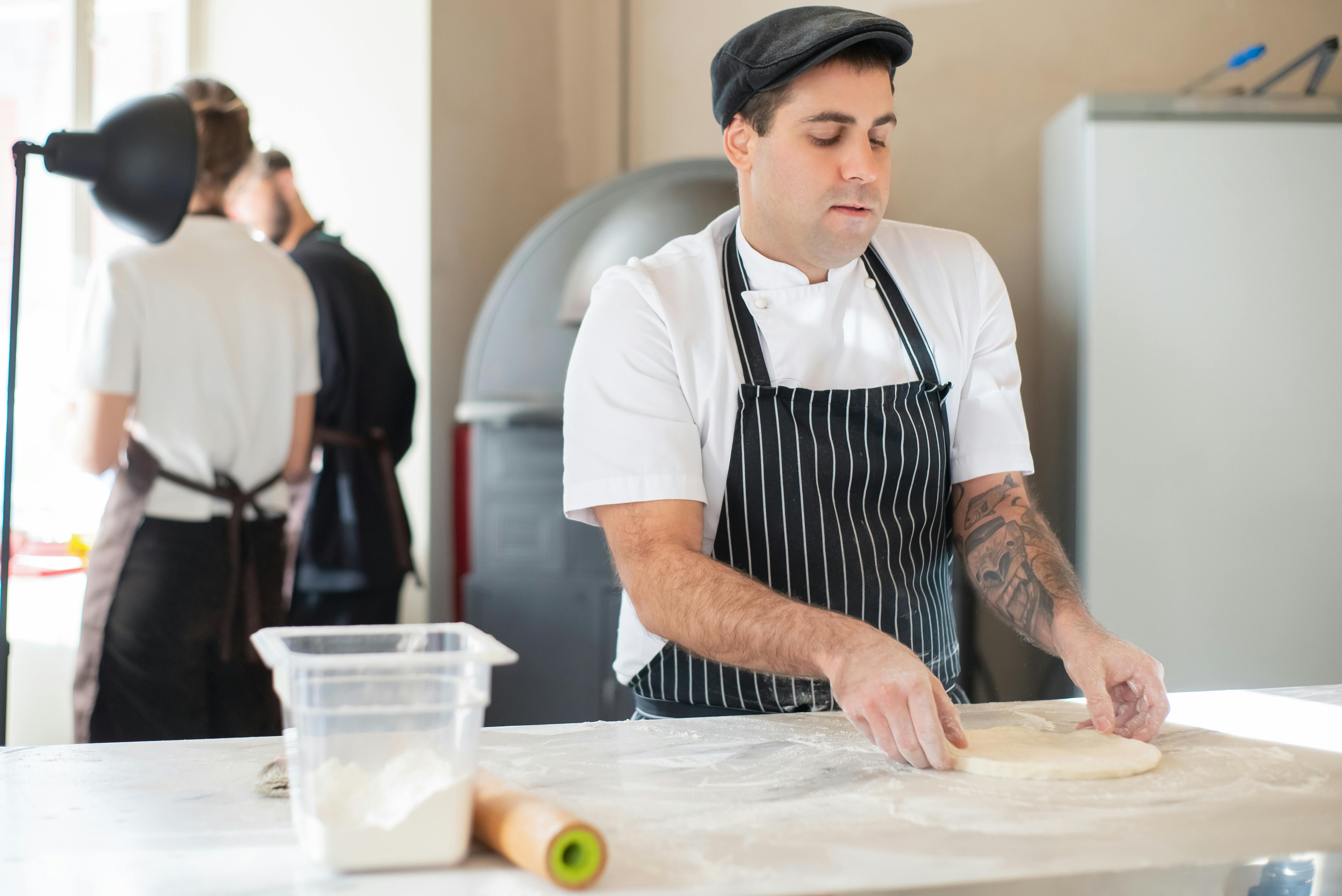 Crop cook breaking egg into flour · Free Stock Photo