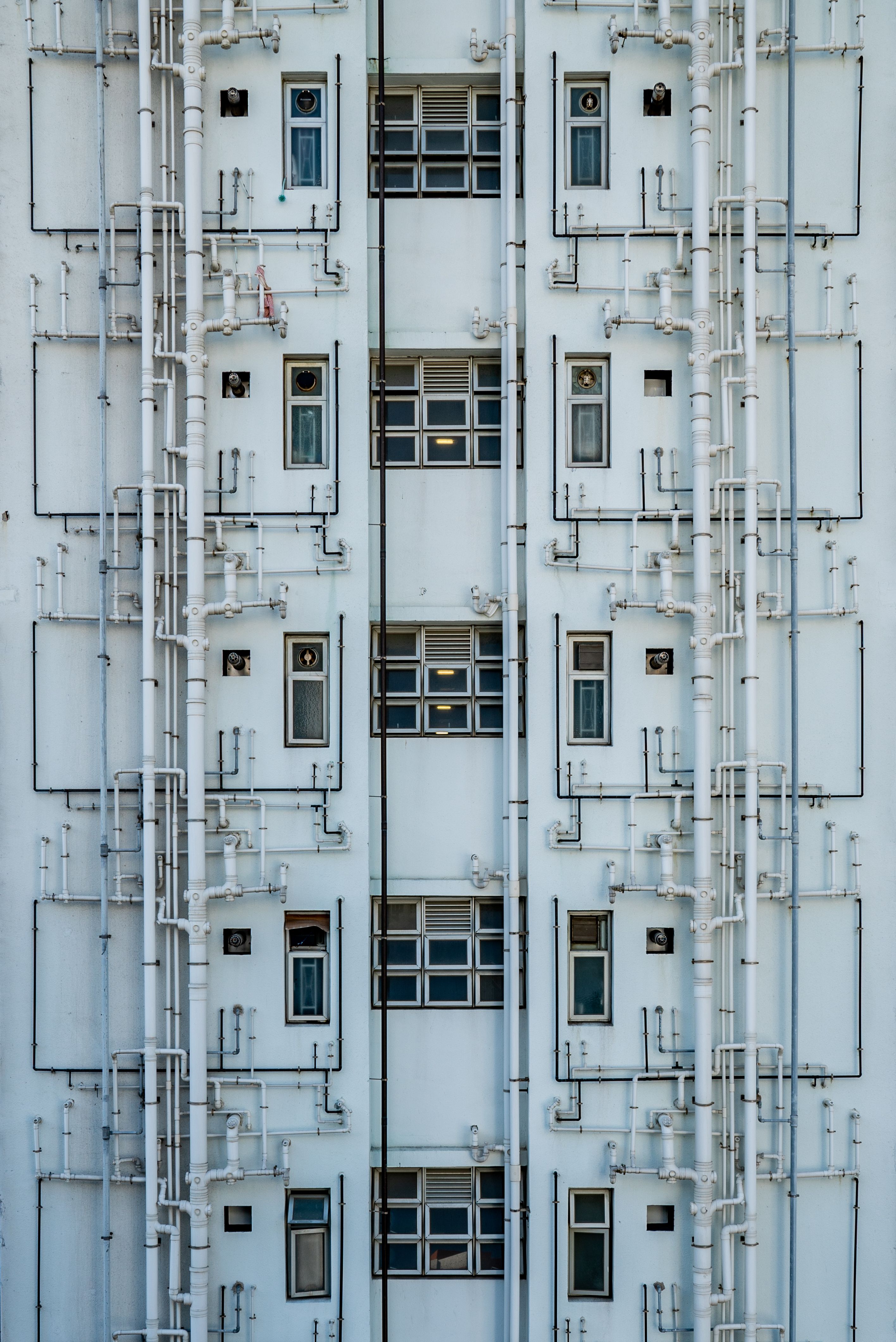 A Multi Level White Building with Metal Pipes · Free Stock Photo