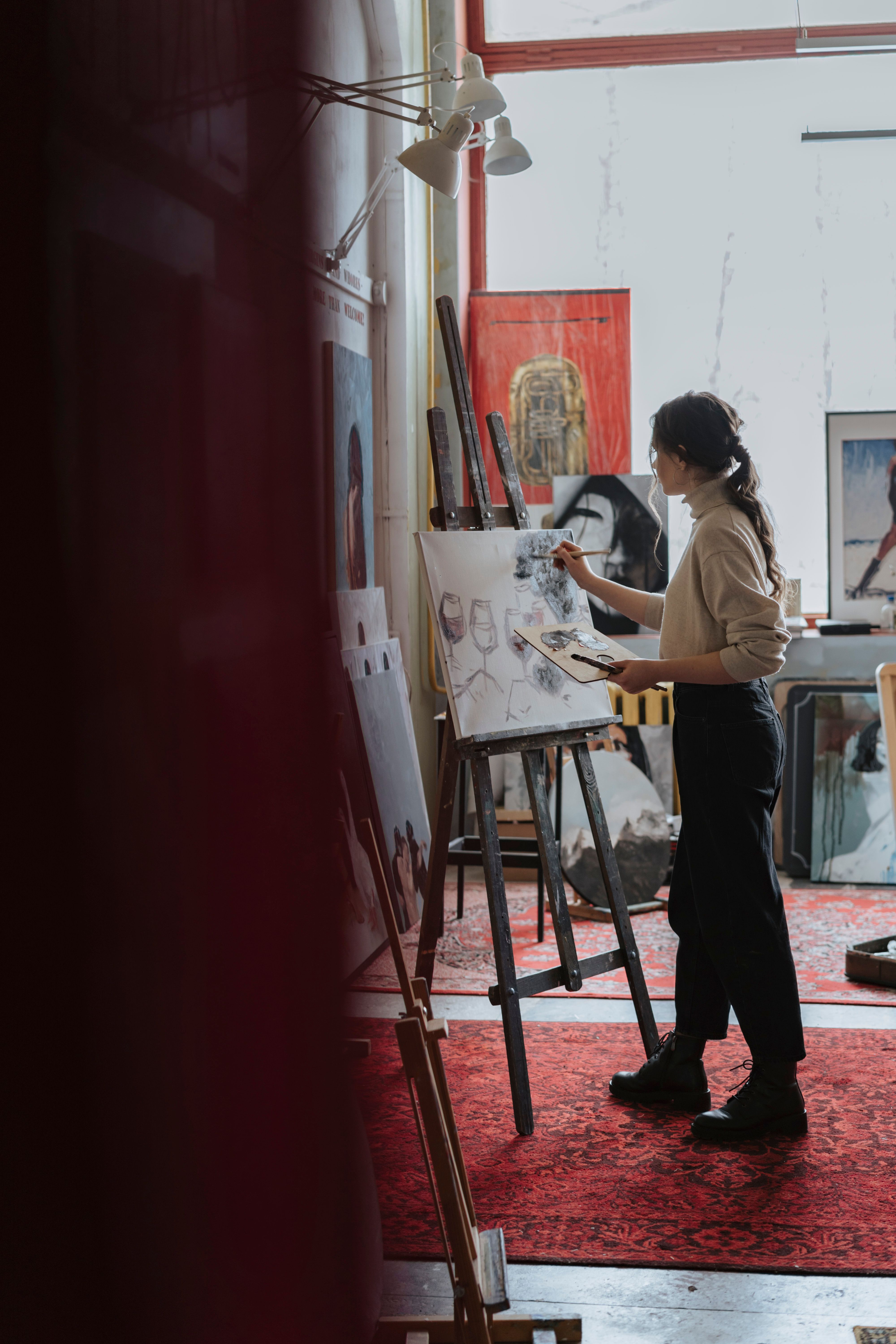 A Woman Painting while Standing · Free Stock Photo