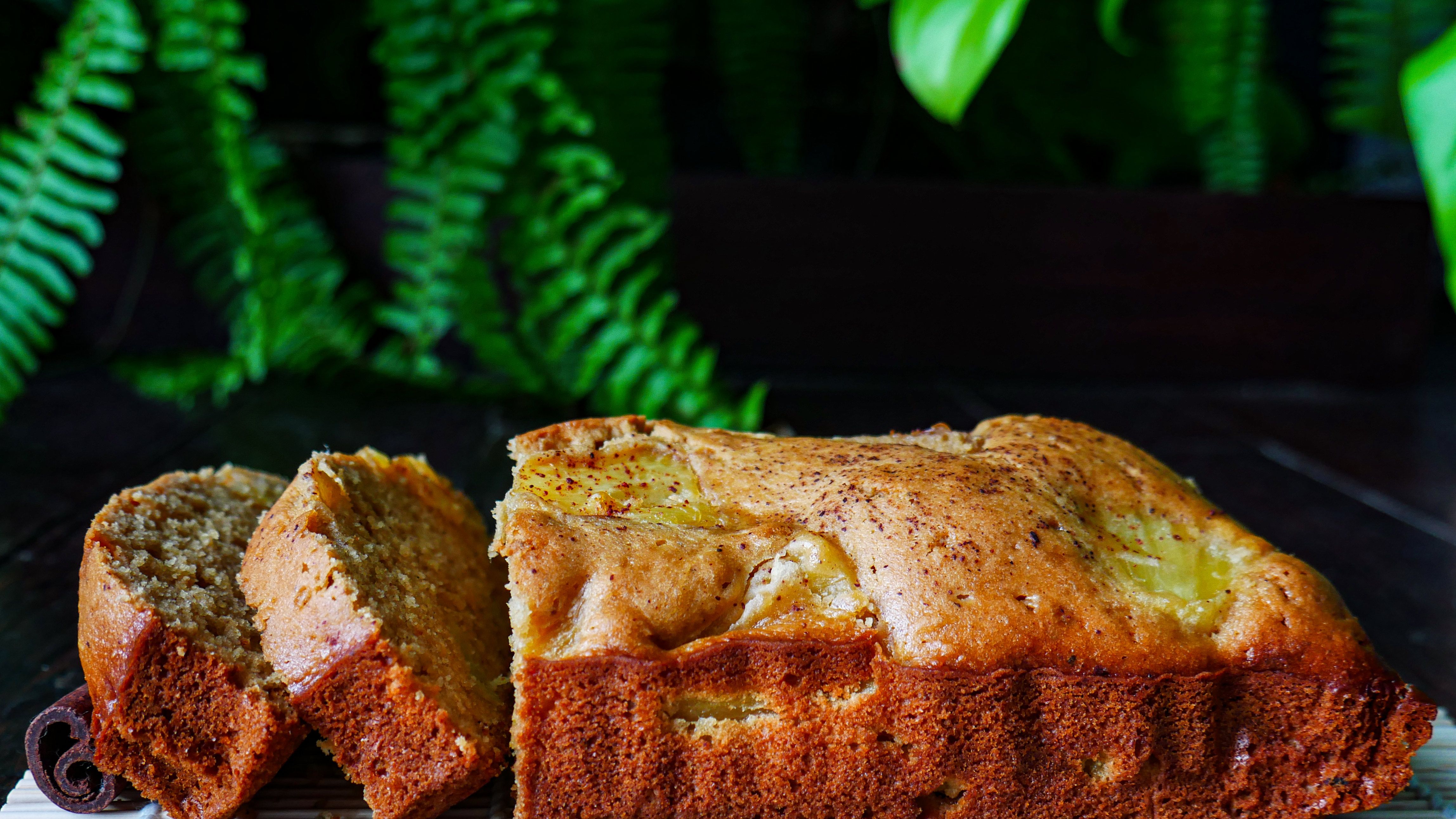 Photo of a Loaf of Bread in a Paper Bag on a Breadboard · Free Stock Photo