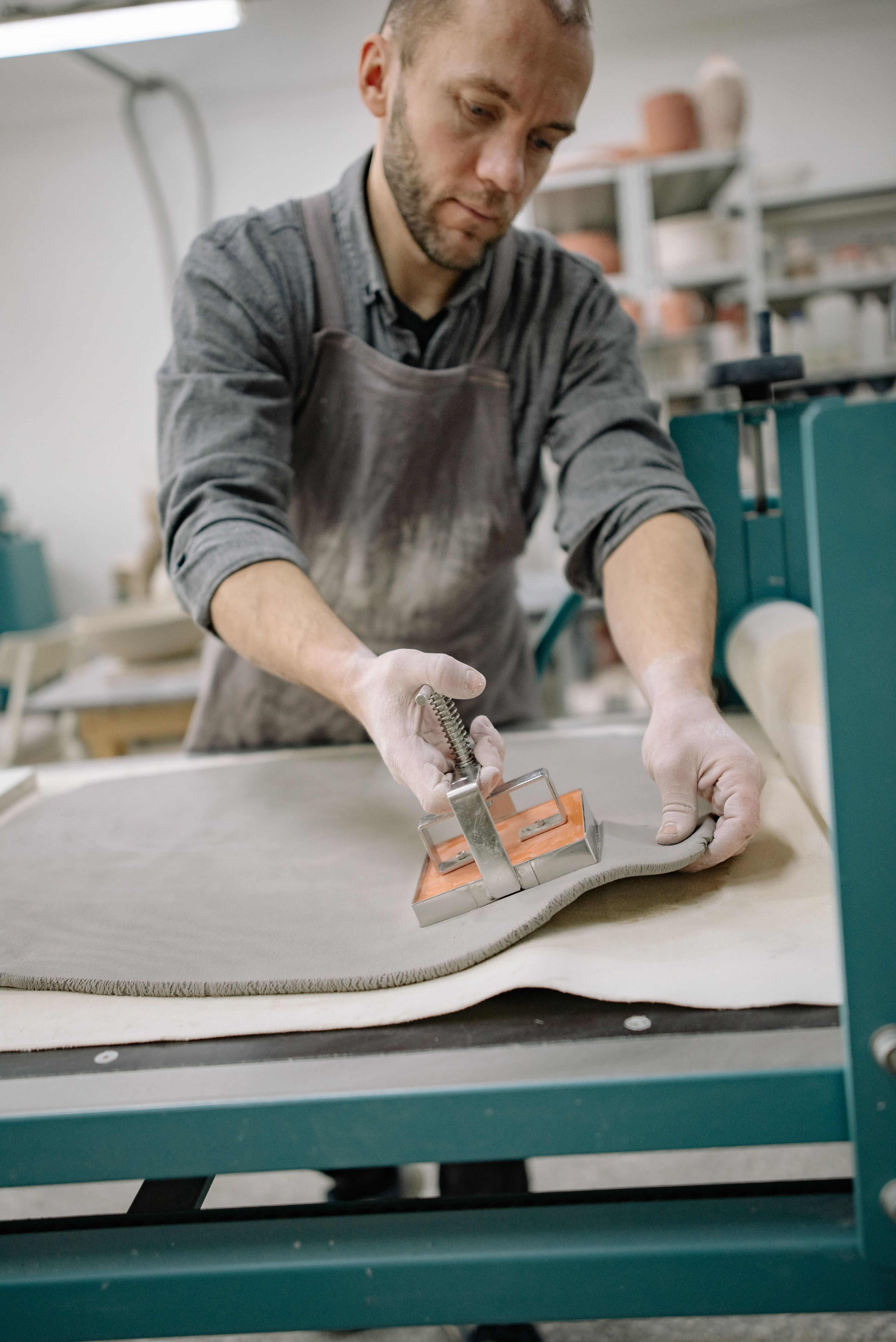 Man Working with Fabric in Workshop · Free Stock Photo