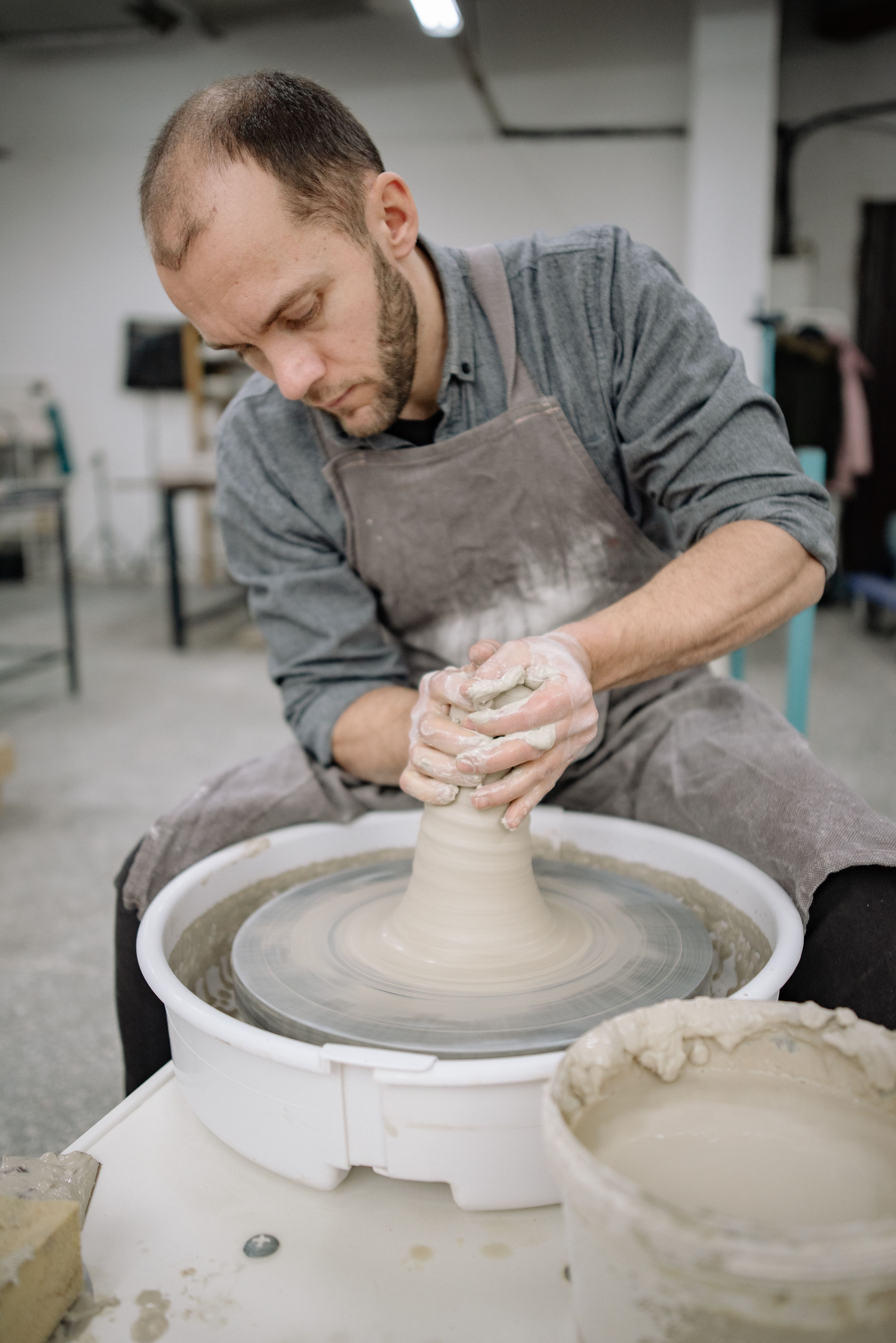 Potter Working with Clay a Pottery Wheel · Free Stock Photo